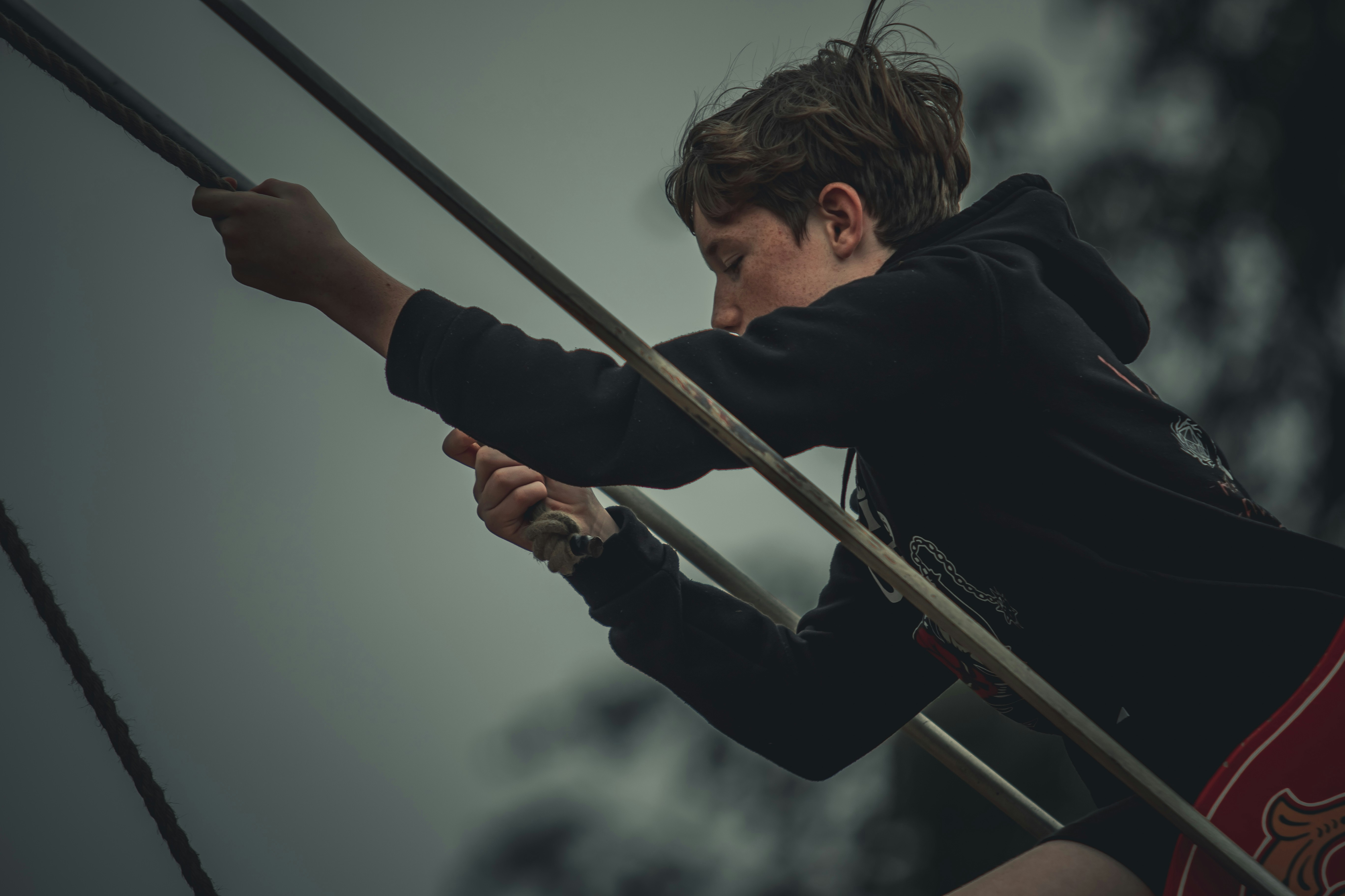 Leaning Focus: A climber holds onto a rope with determined stance