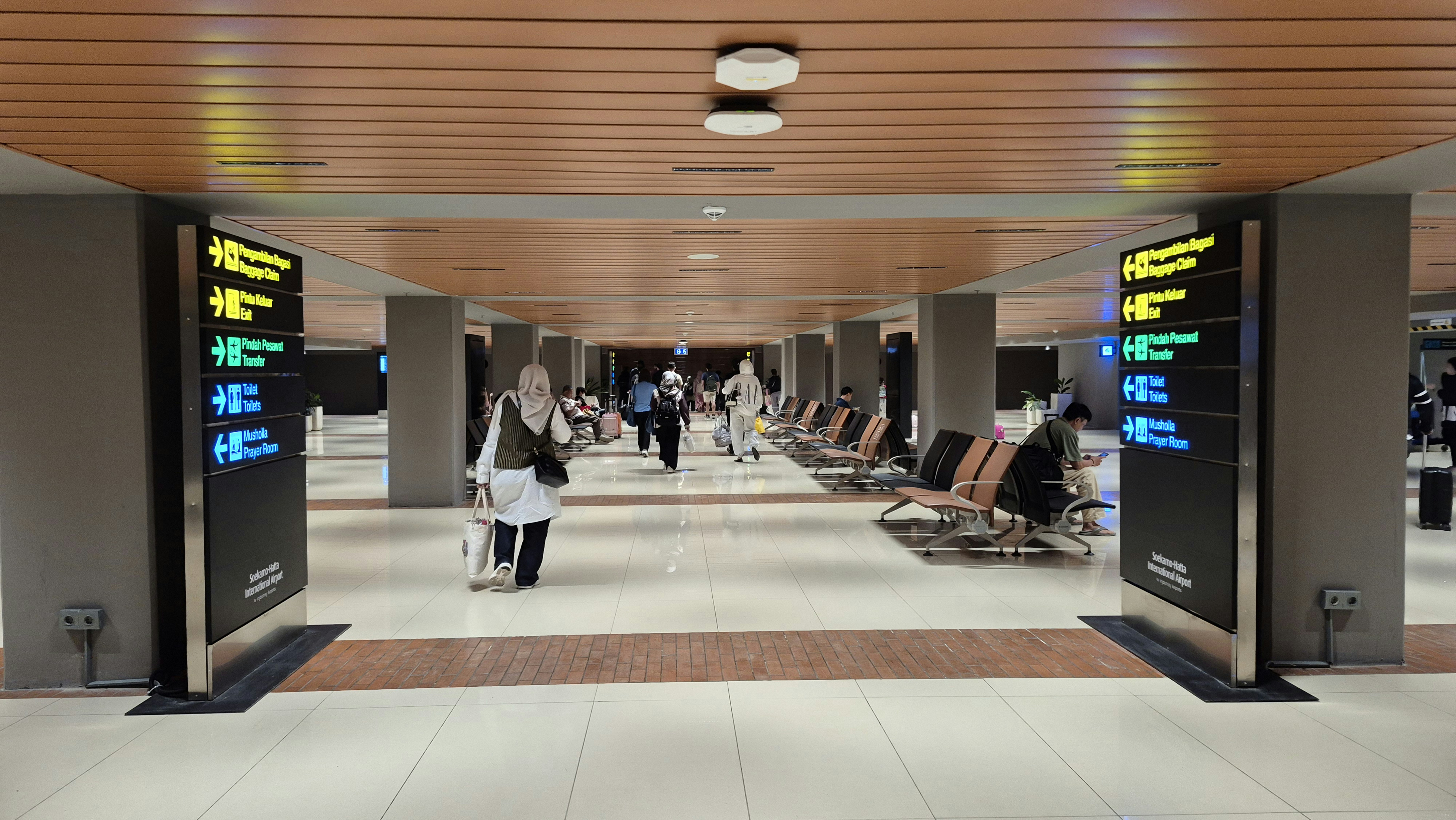Transit Hallway: Quiet Travelers in a Sunlit Station