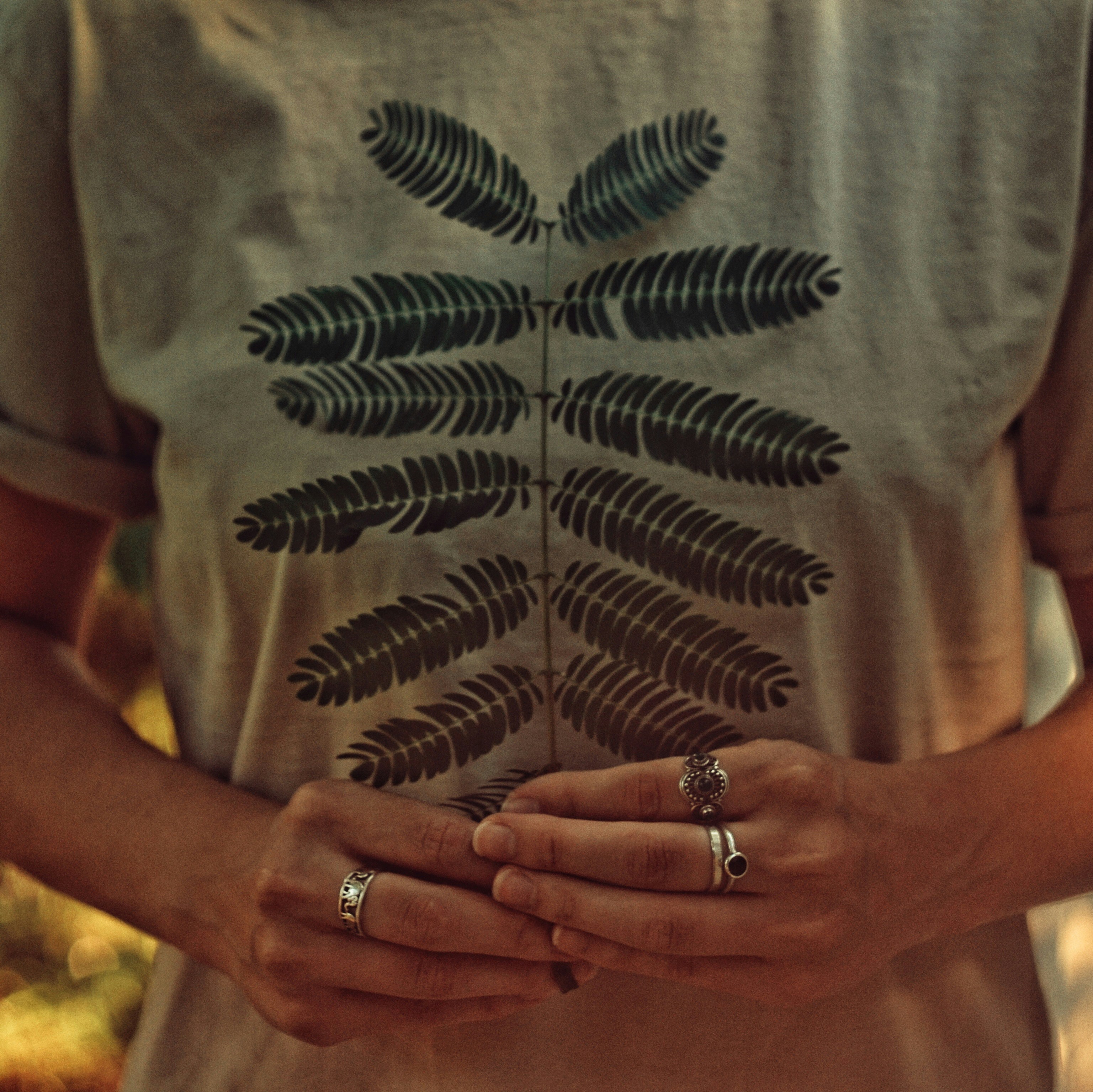 Fern Silhouette: Delicate Hands Beneath a Leafy Print