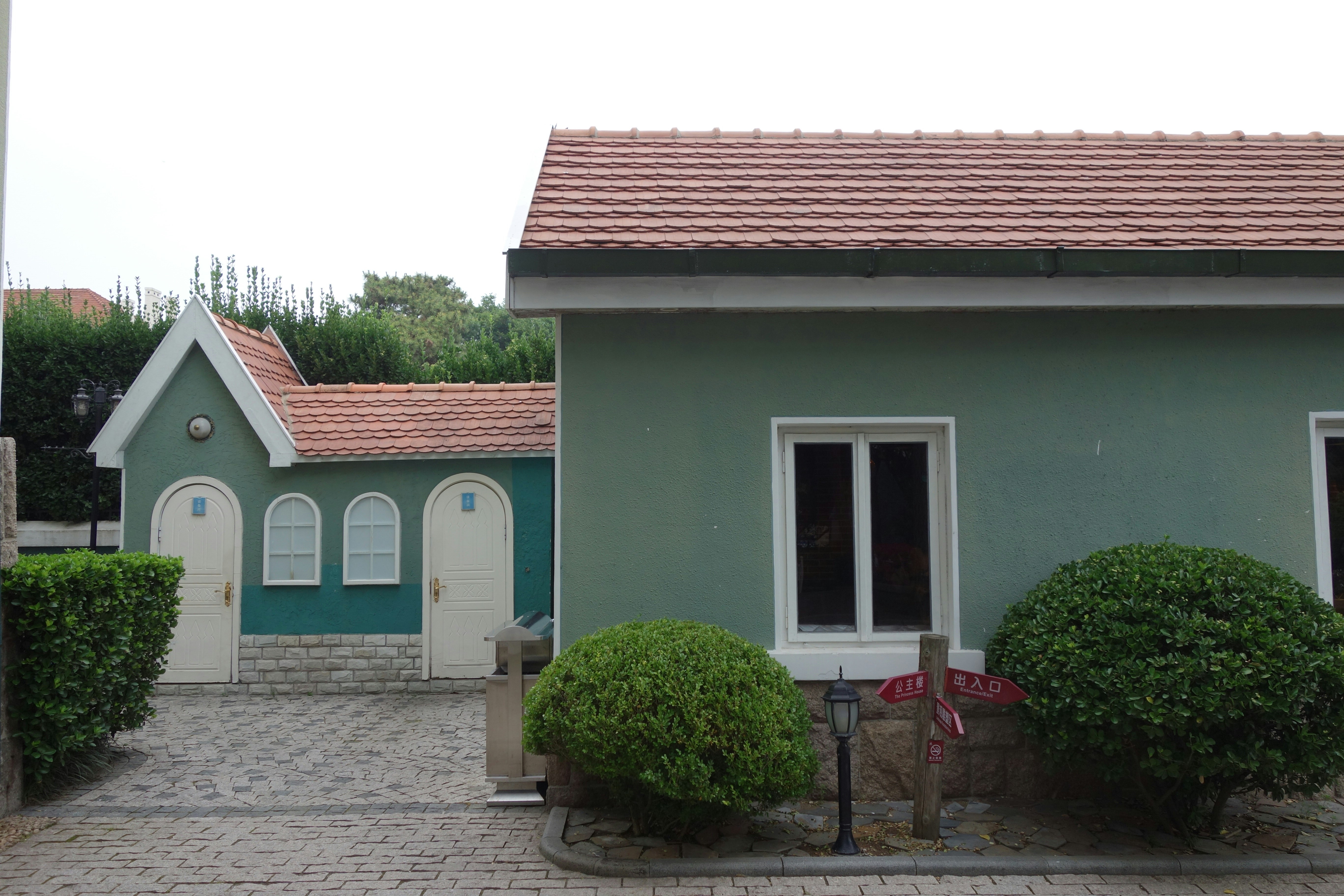 Quiet Courtyard with Lip of Greenery and Painted Homes