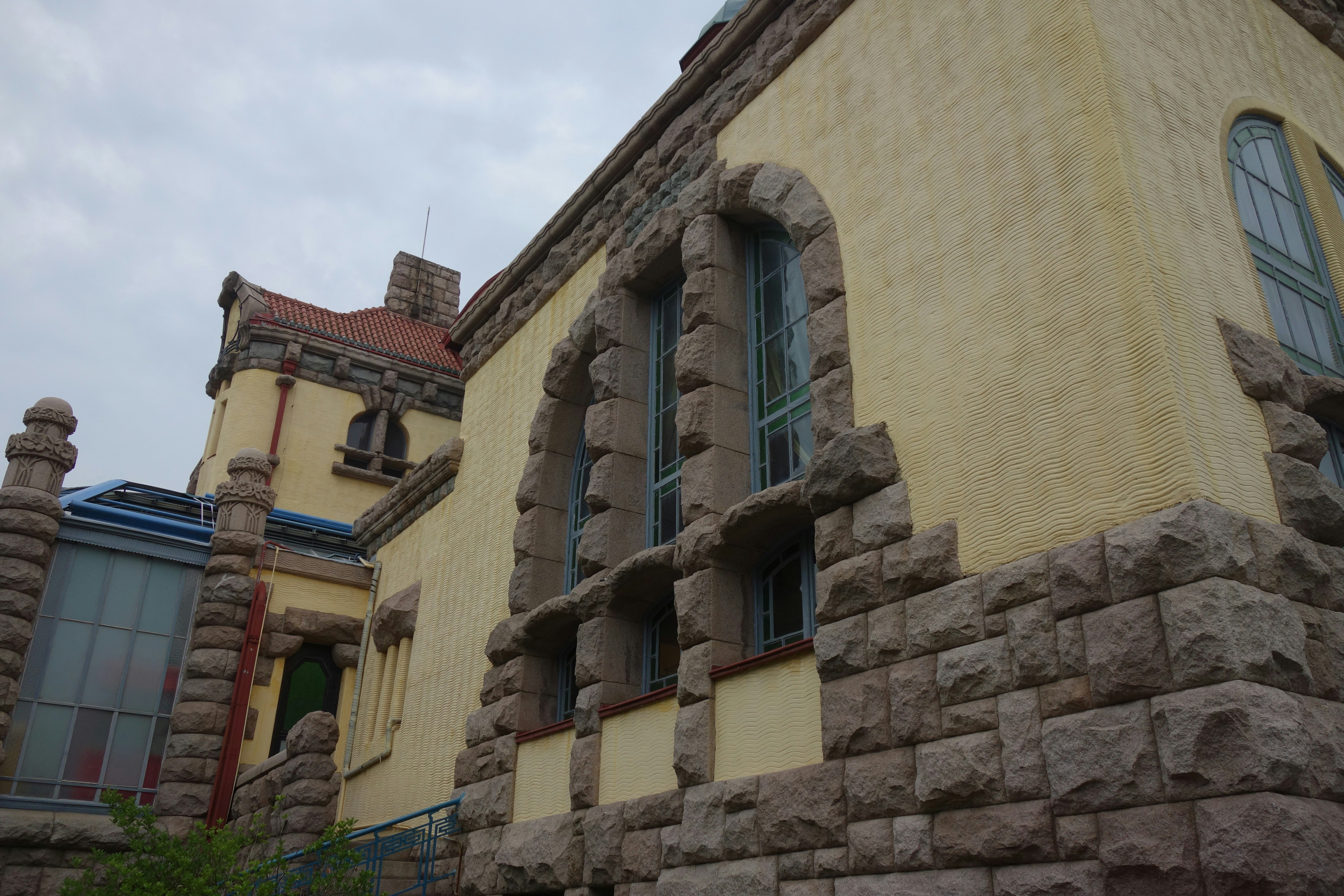Stone Arches and Yellow Brick Facade: A Corner of Architectural Detail