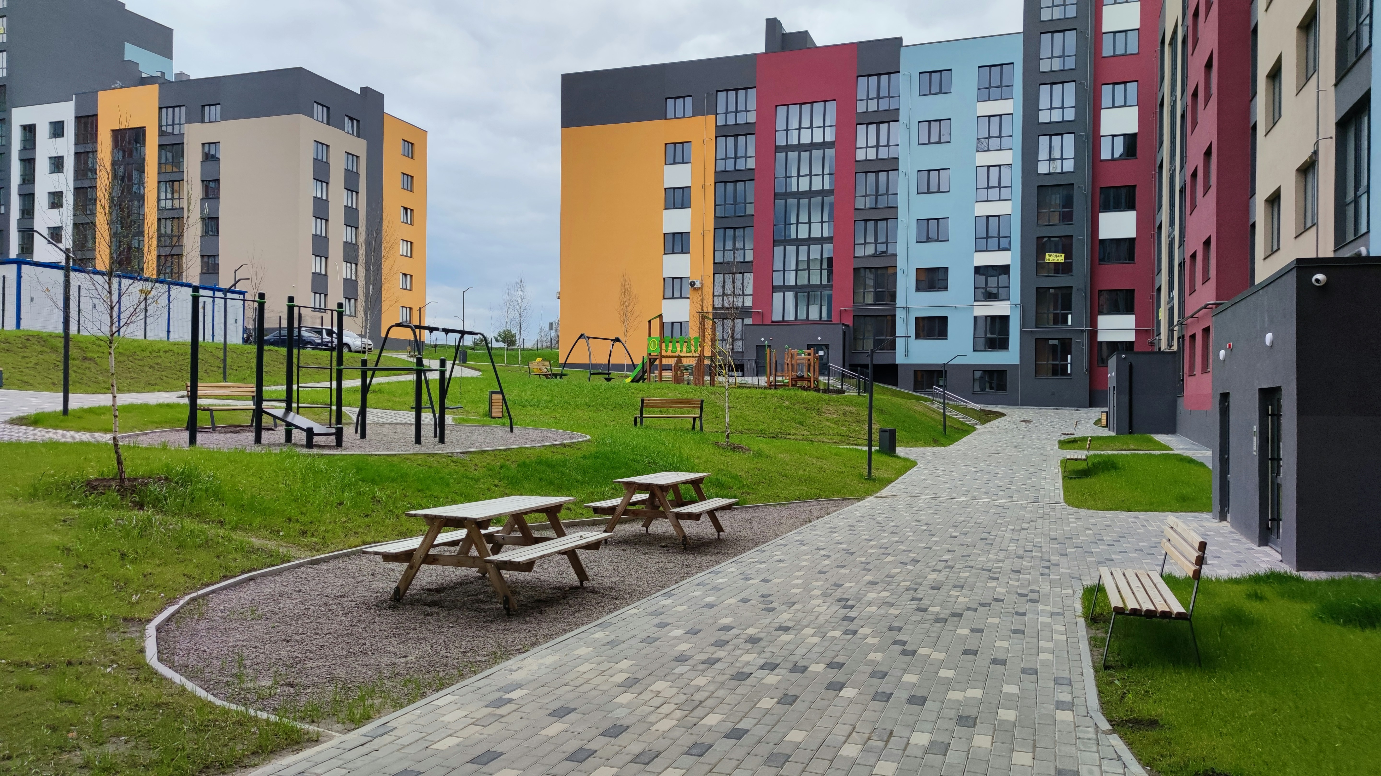 Colorful residential courtyard under a blue-sky afternoon