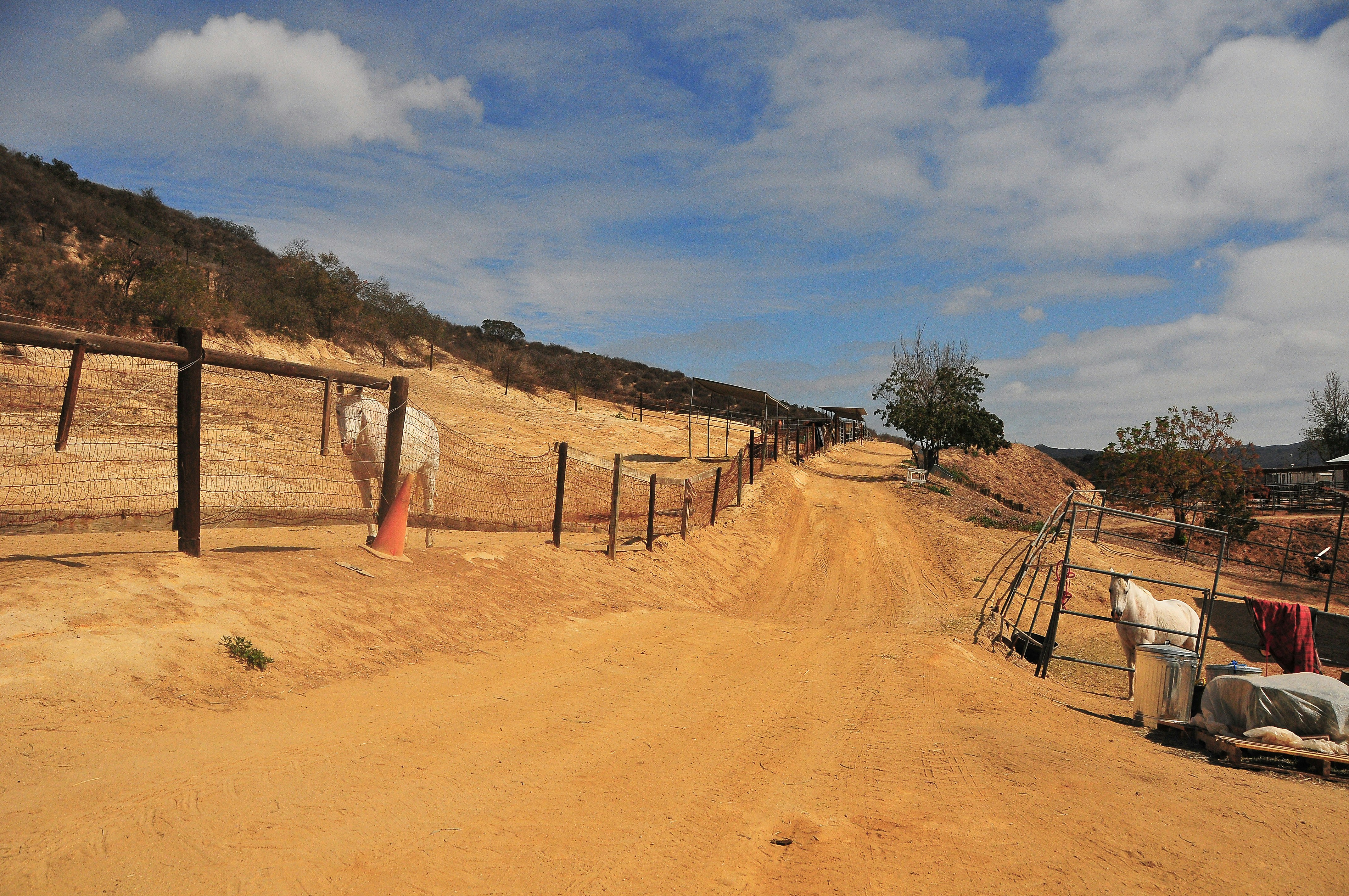 Dusty Rural Road Leading to Distant Hills