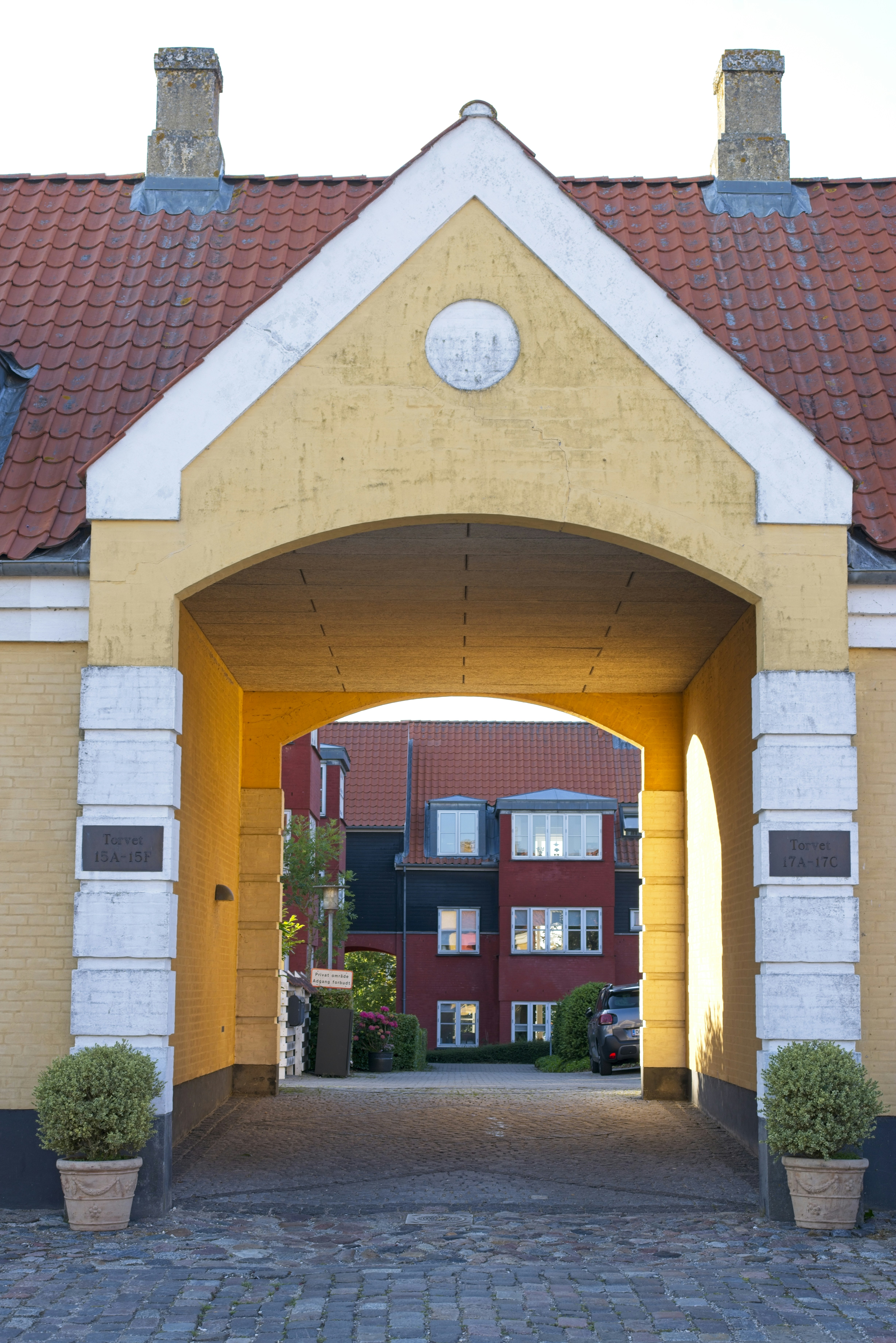 Golden Archway Gate: A Sunlit Passage to a Quiet Street