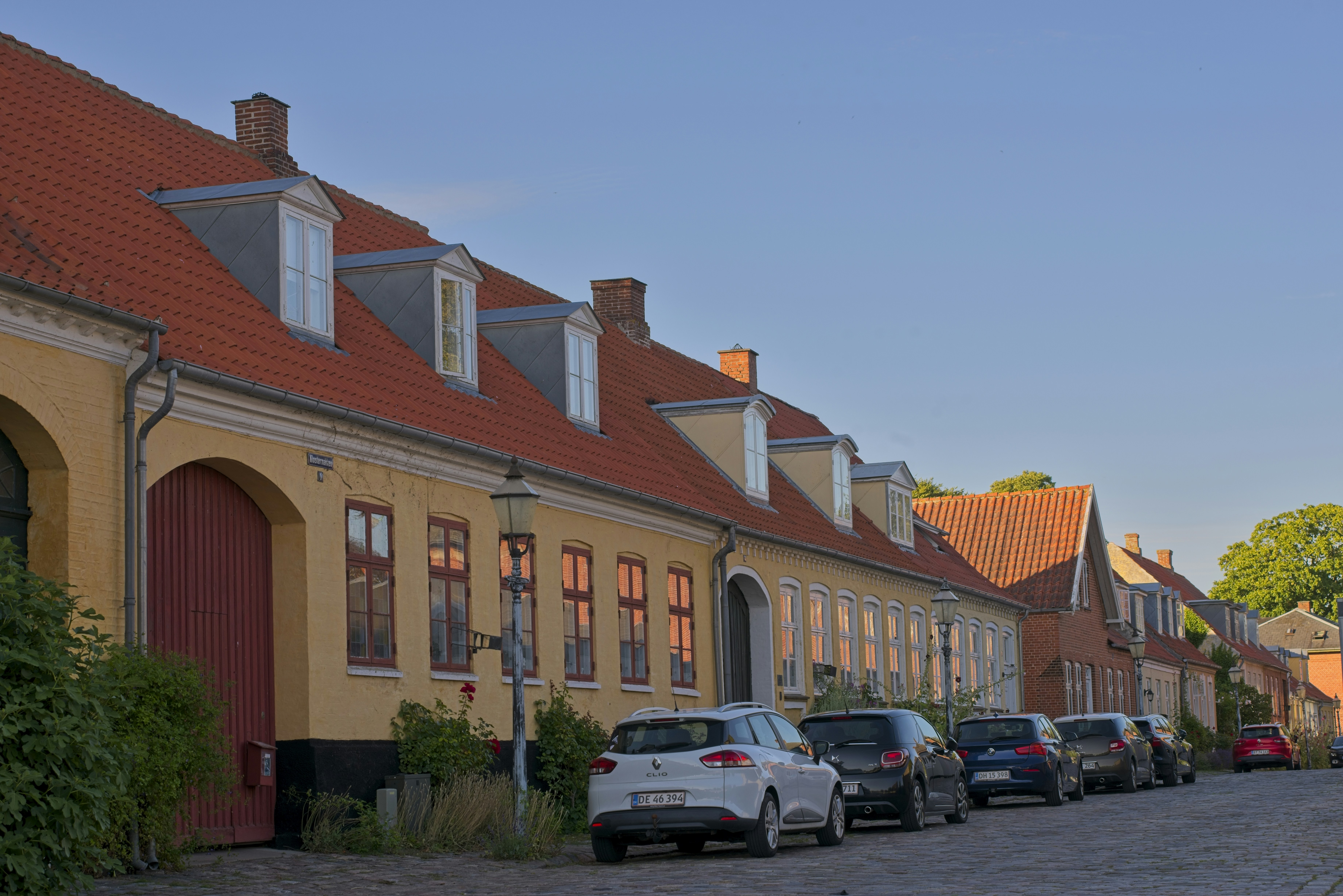 Sunlit Row: Terracotta Roofs and a Quiet Cobblestone Street