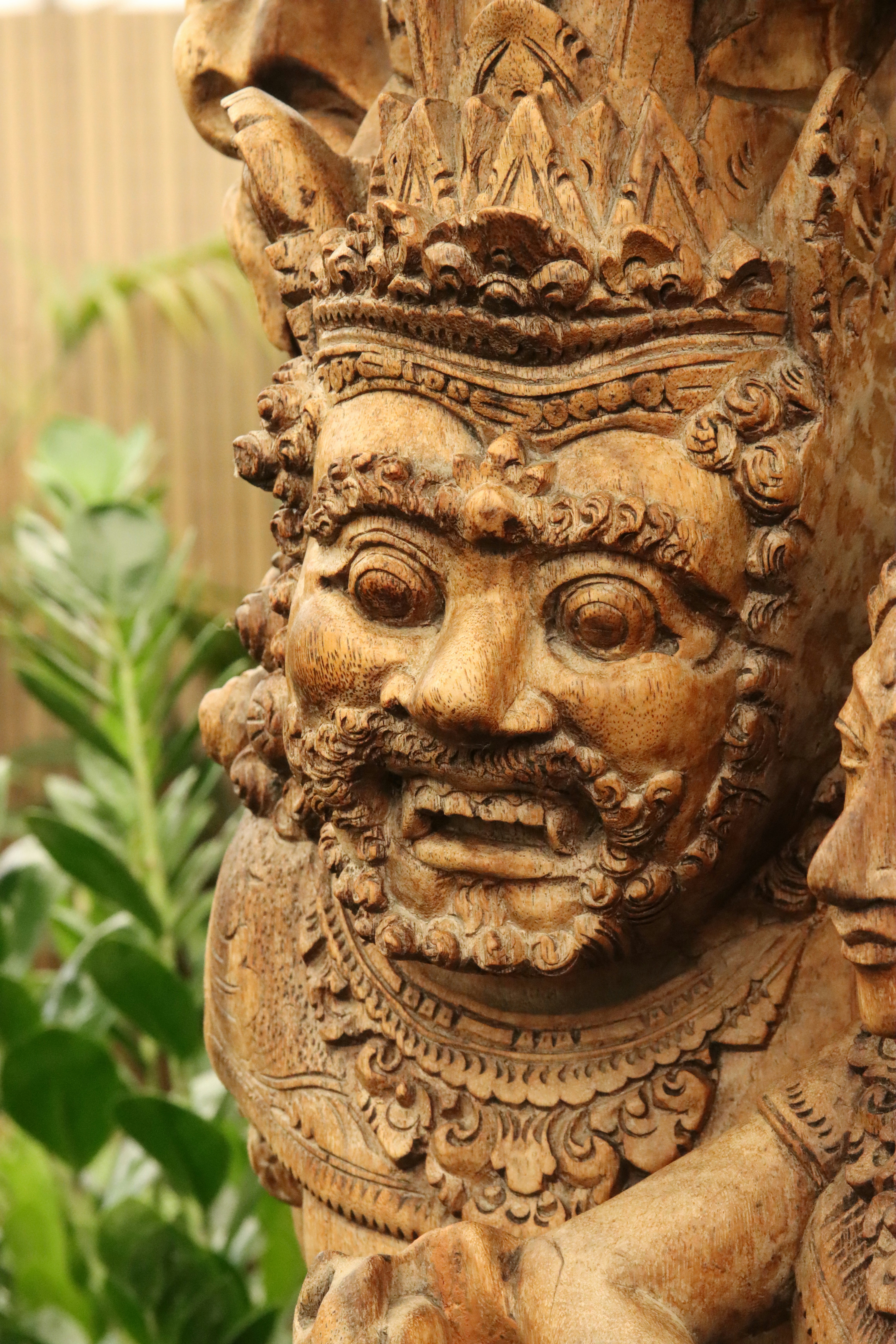 Carved Guardian: A Gnarled Face Emerging from Stone