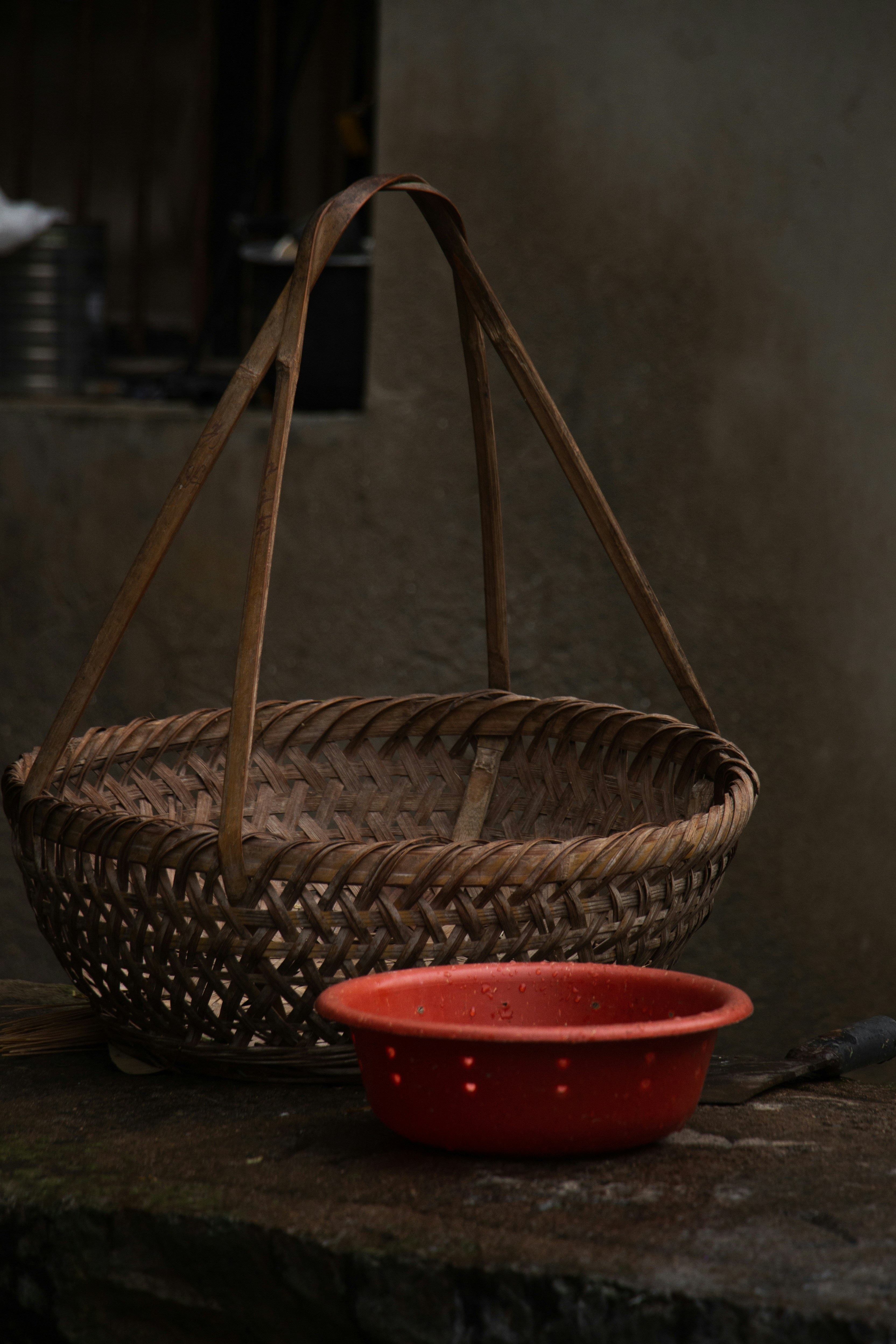Rust and Red: A Basket Rest by the Dim Wall