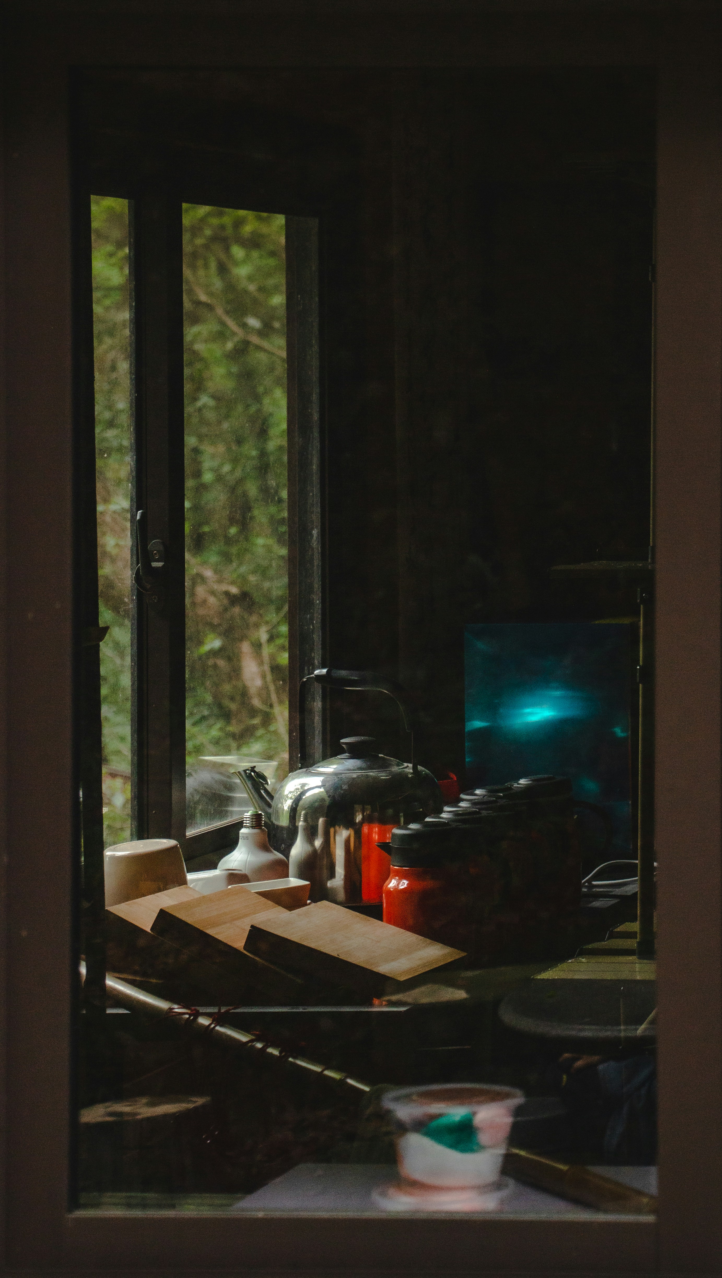 Sunlit Pathway to a Quiet Kitchen: A Window into Clutter and Craft