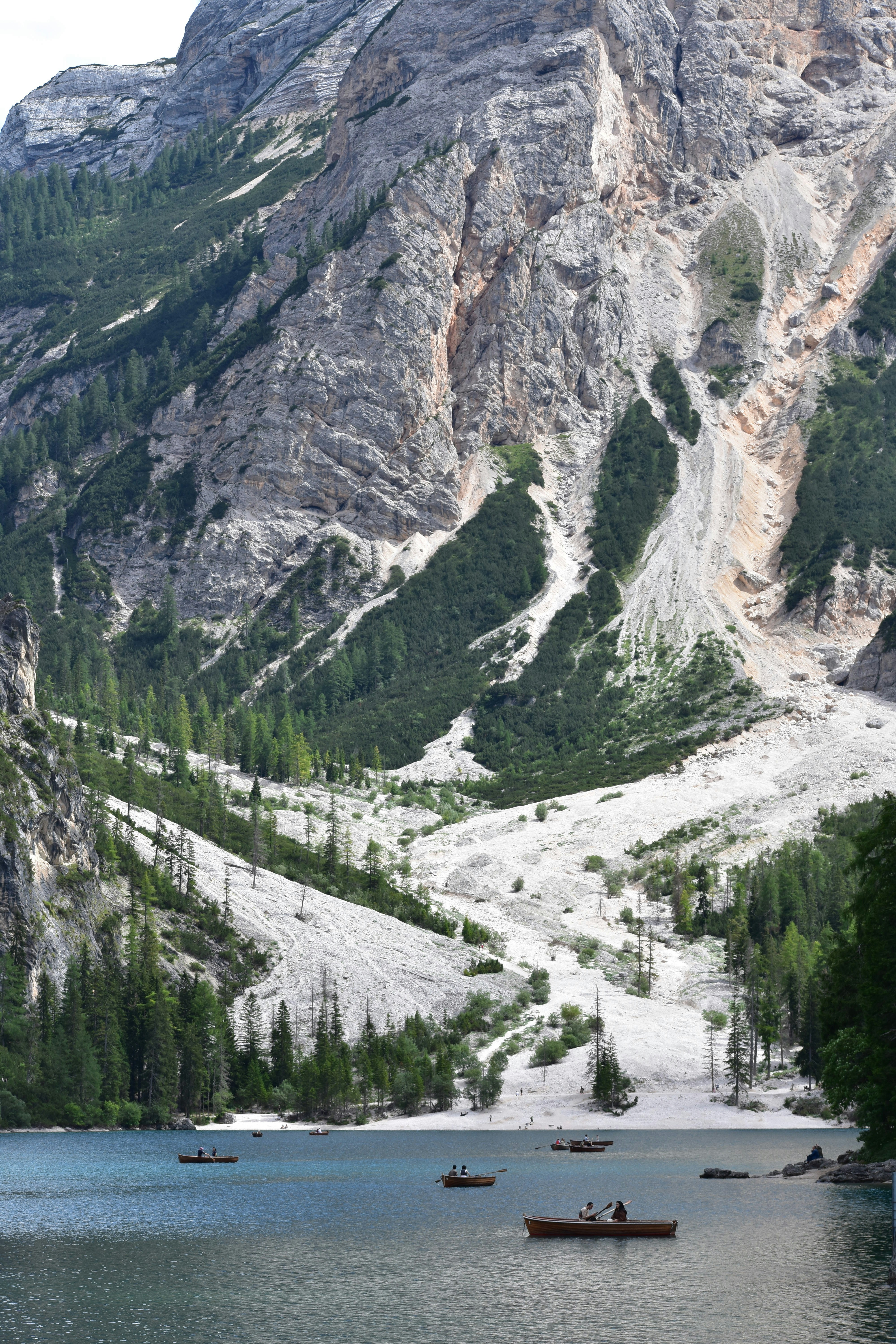 Mist on the Mountain Lake: Boats at the Foot of Jagged Peaks