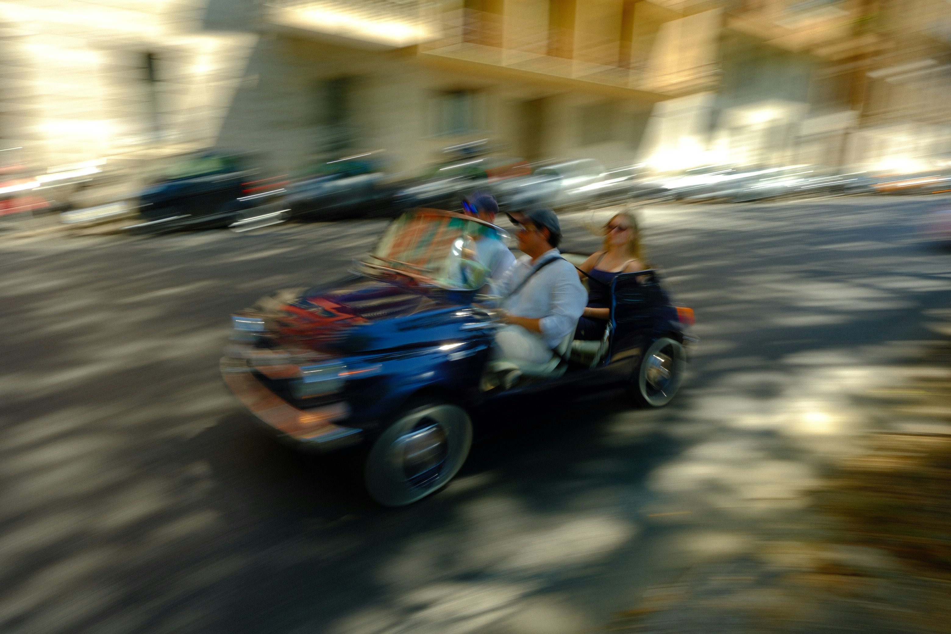 Motion on the Boulevard: A Blurred Convertible Dash