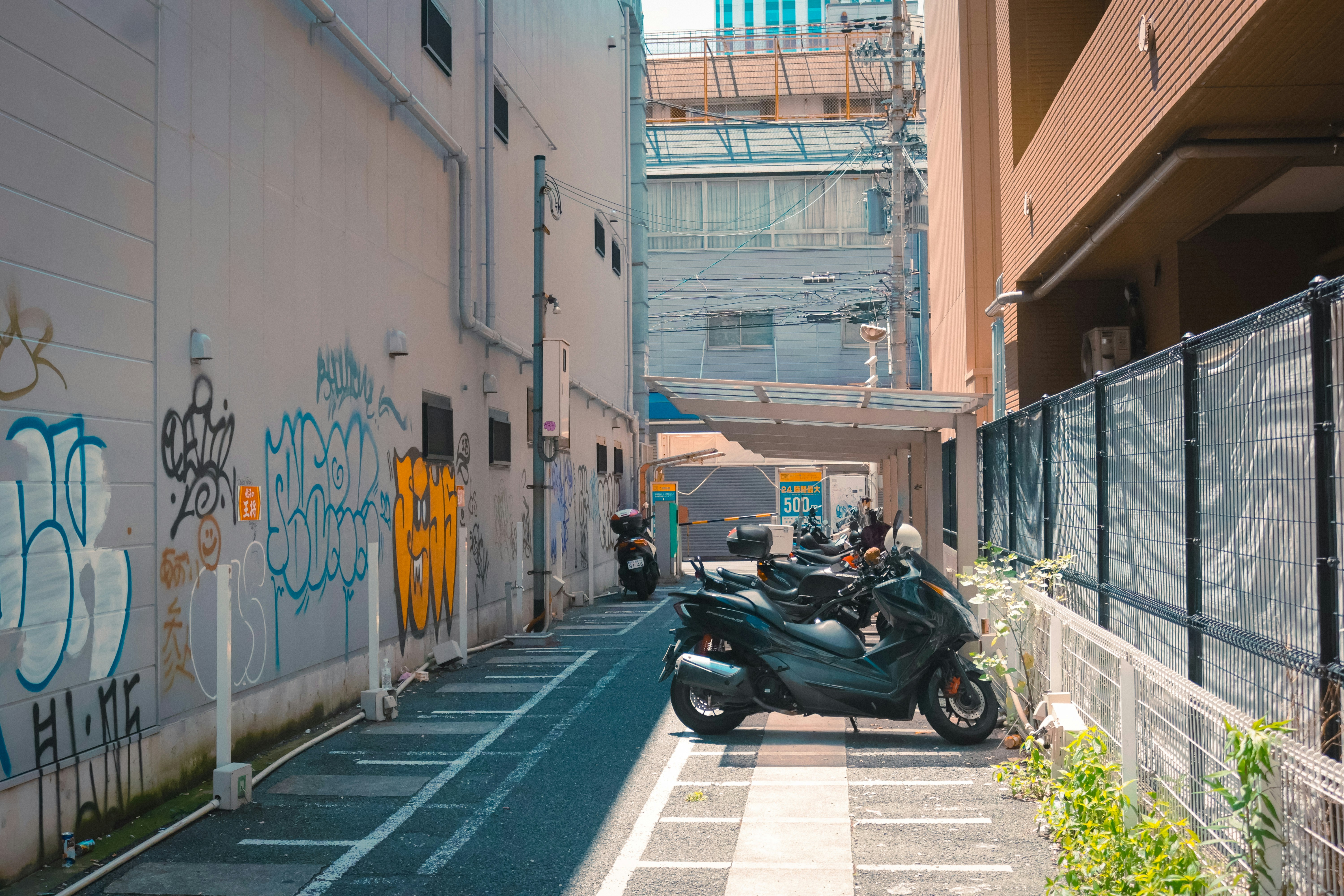 Scooters in a Quiet Alley Reach Toward the Light