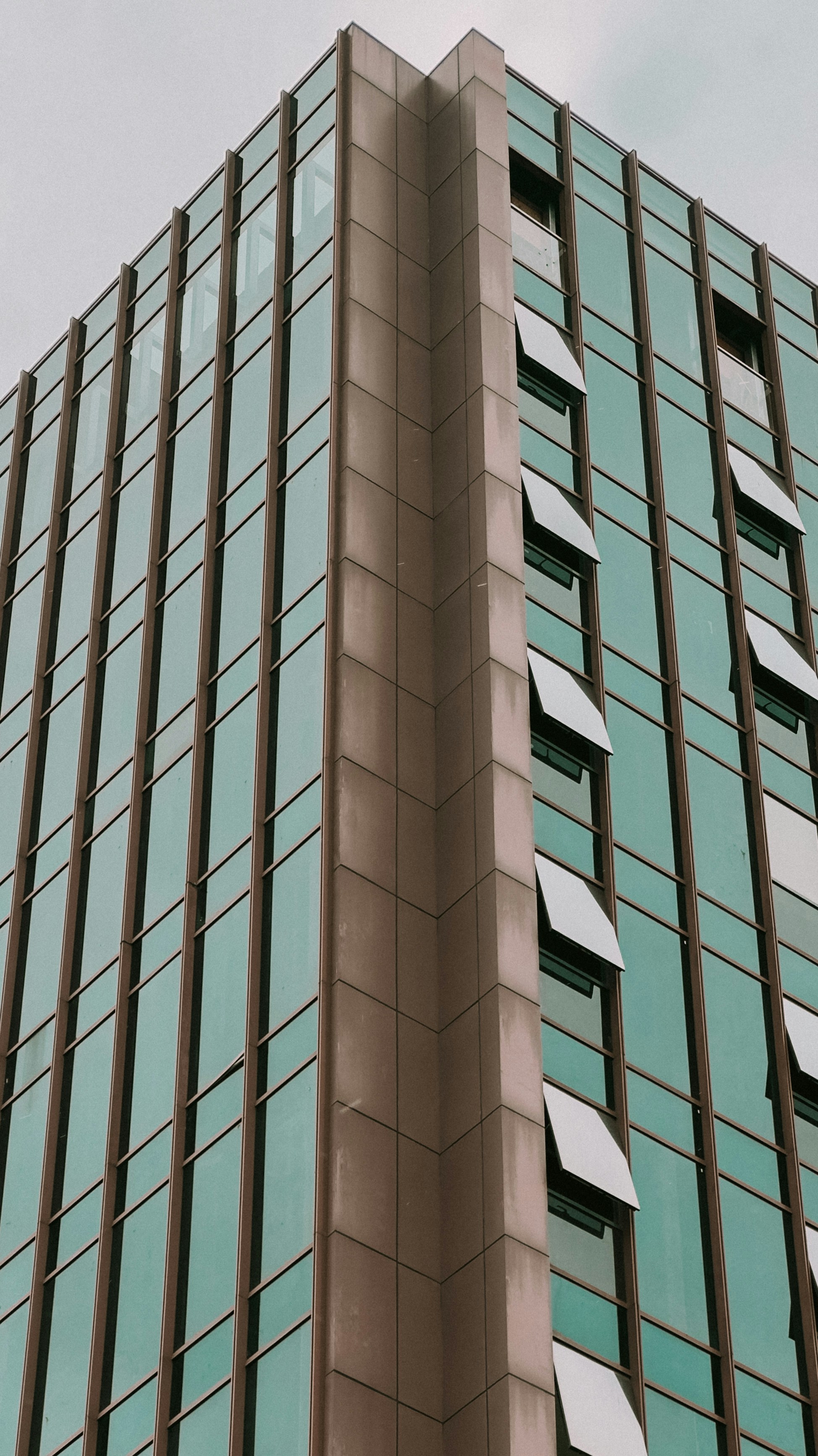 Vertical Facade: Converging Glass and Concrete Lines