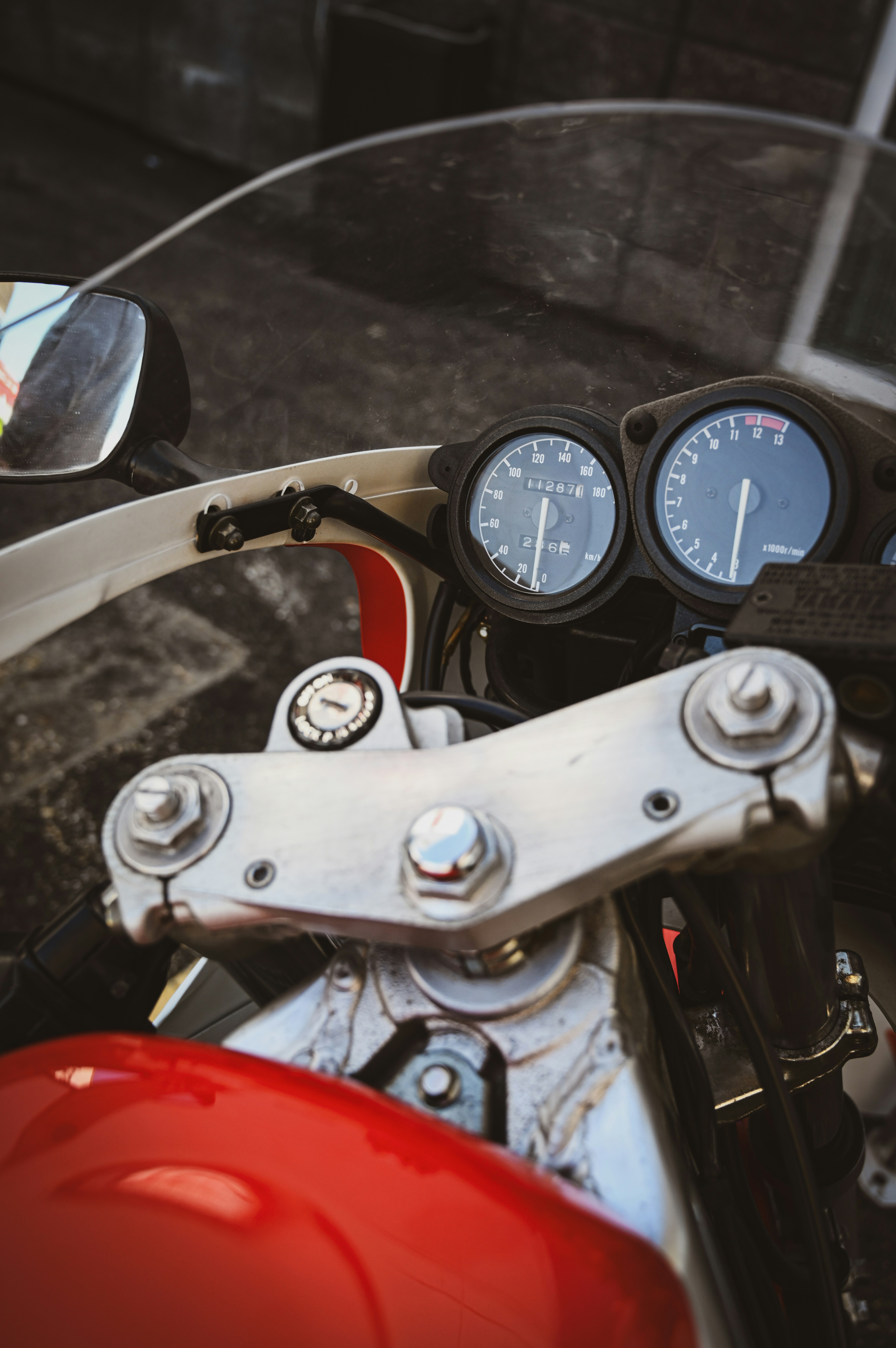 Chrome and Courage: Close-Up of a Red Motorcycle Dash