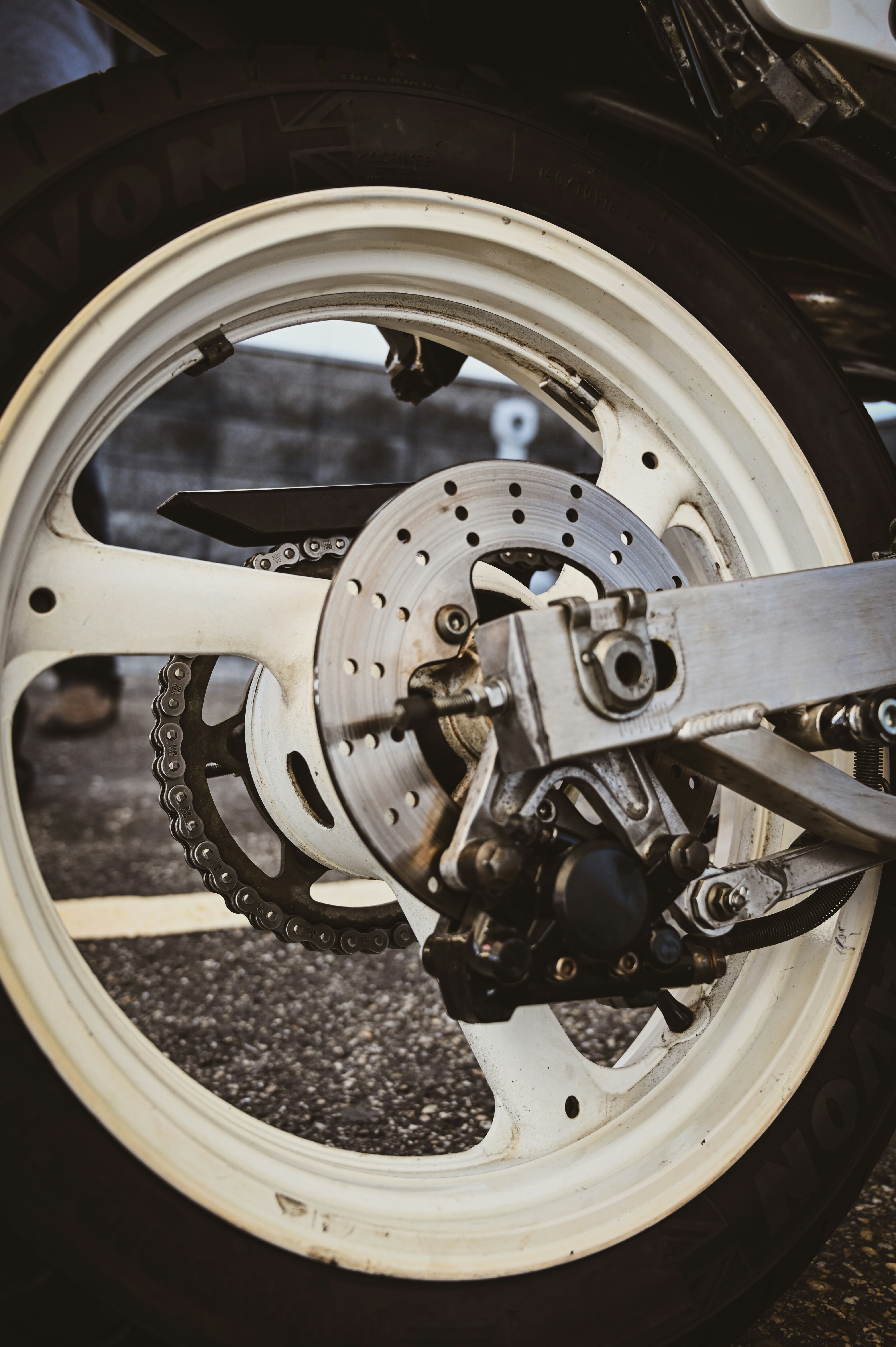 White-wheeled motion: close-up of a motorcycle rear hub and disc brake