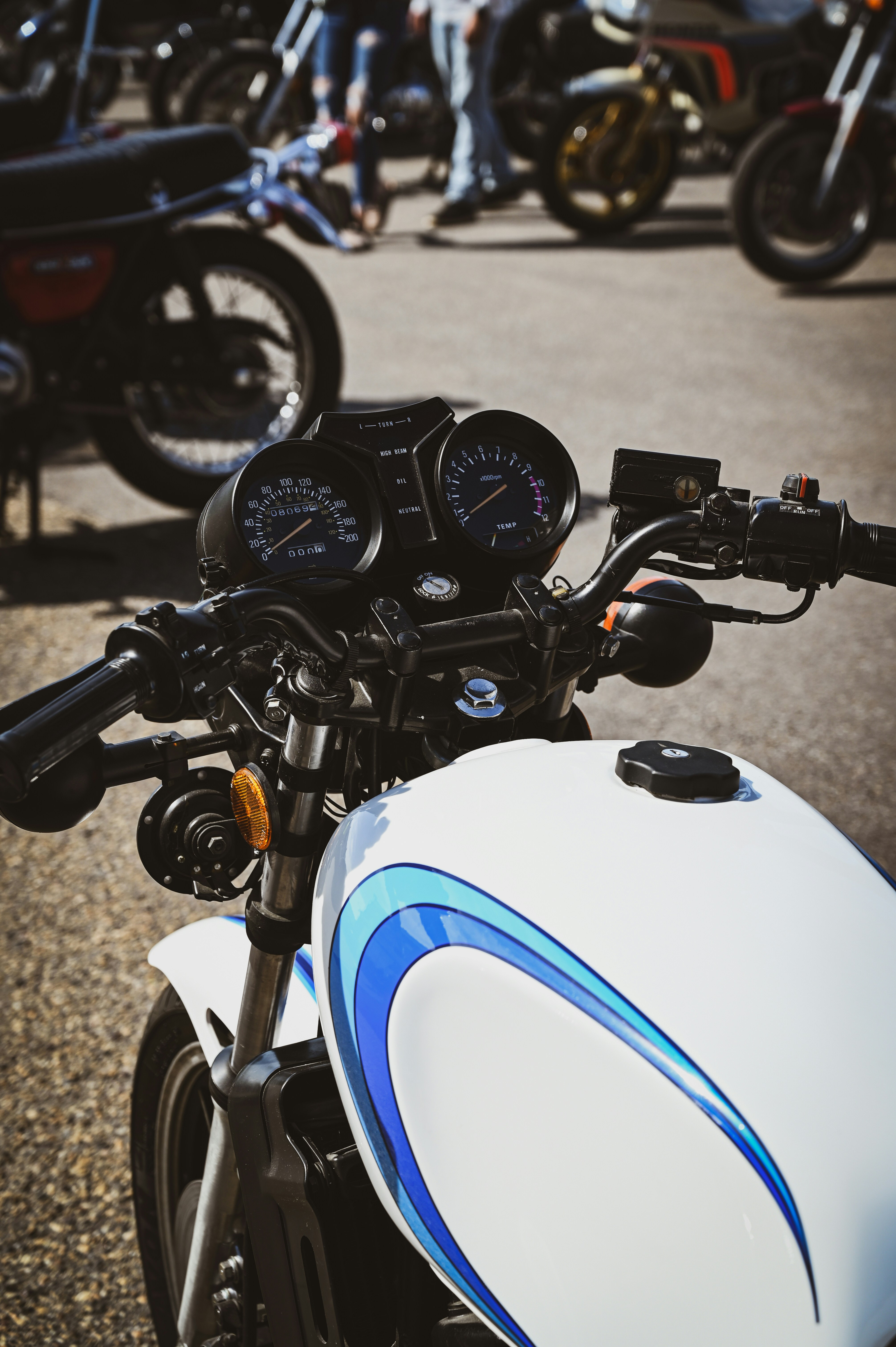 Blue-Silver Tank Crest: A close-up of a vintage-style motorcycle cockpit
