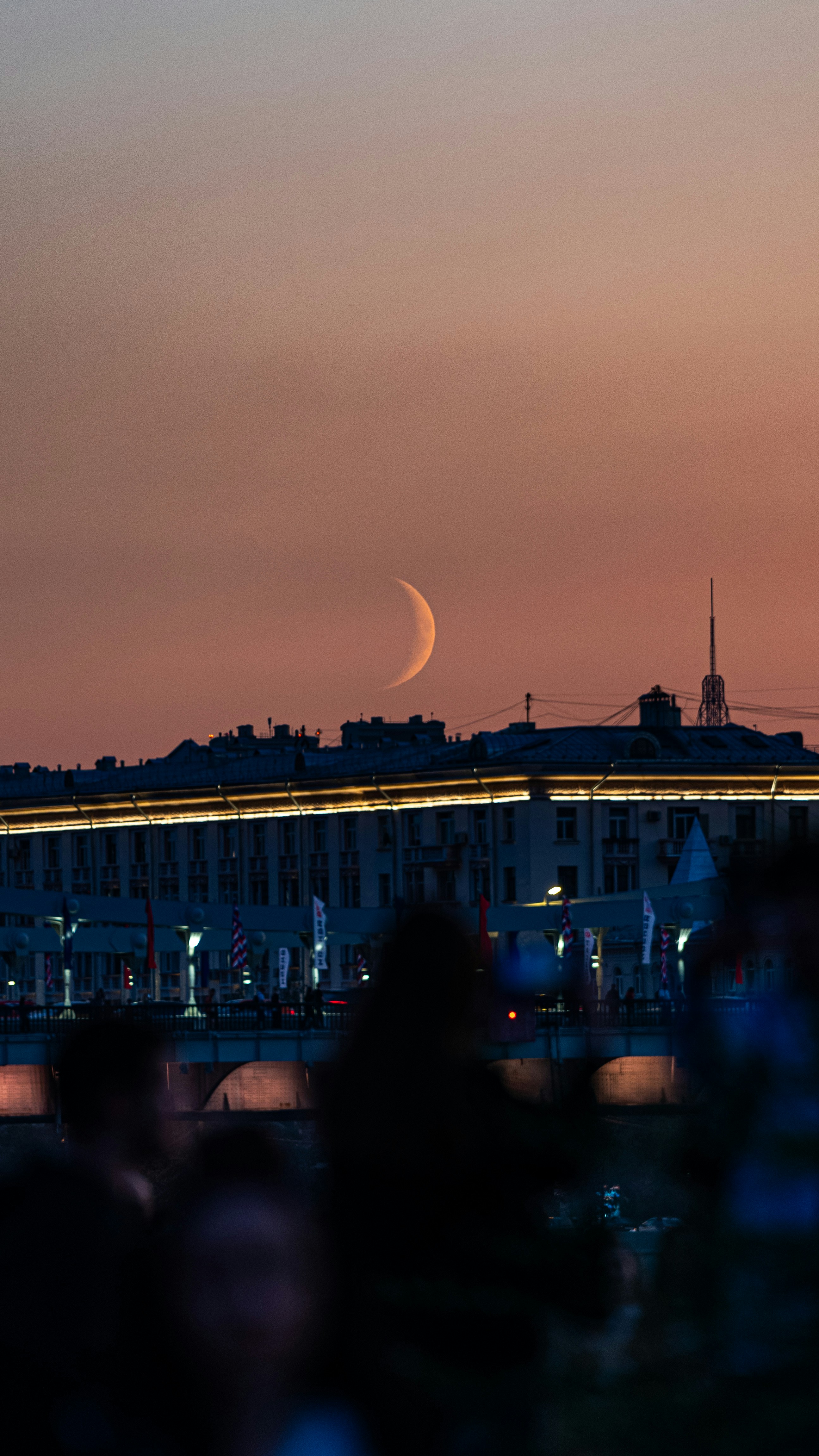 Crescent at Dusk Over a Quiet City Riverside