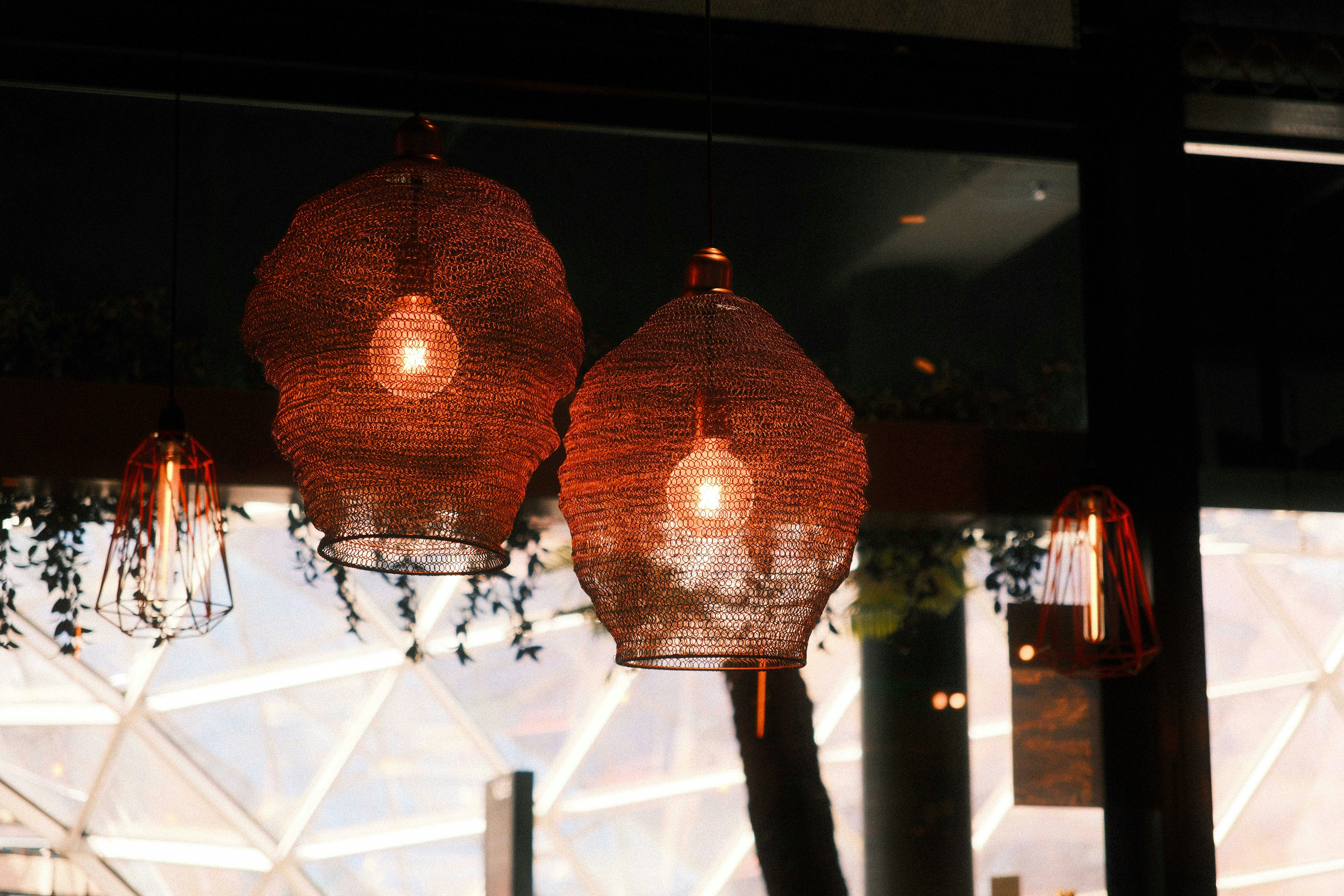 Warm glow from two organic woven pendant lights.
