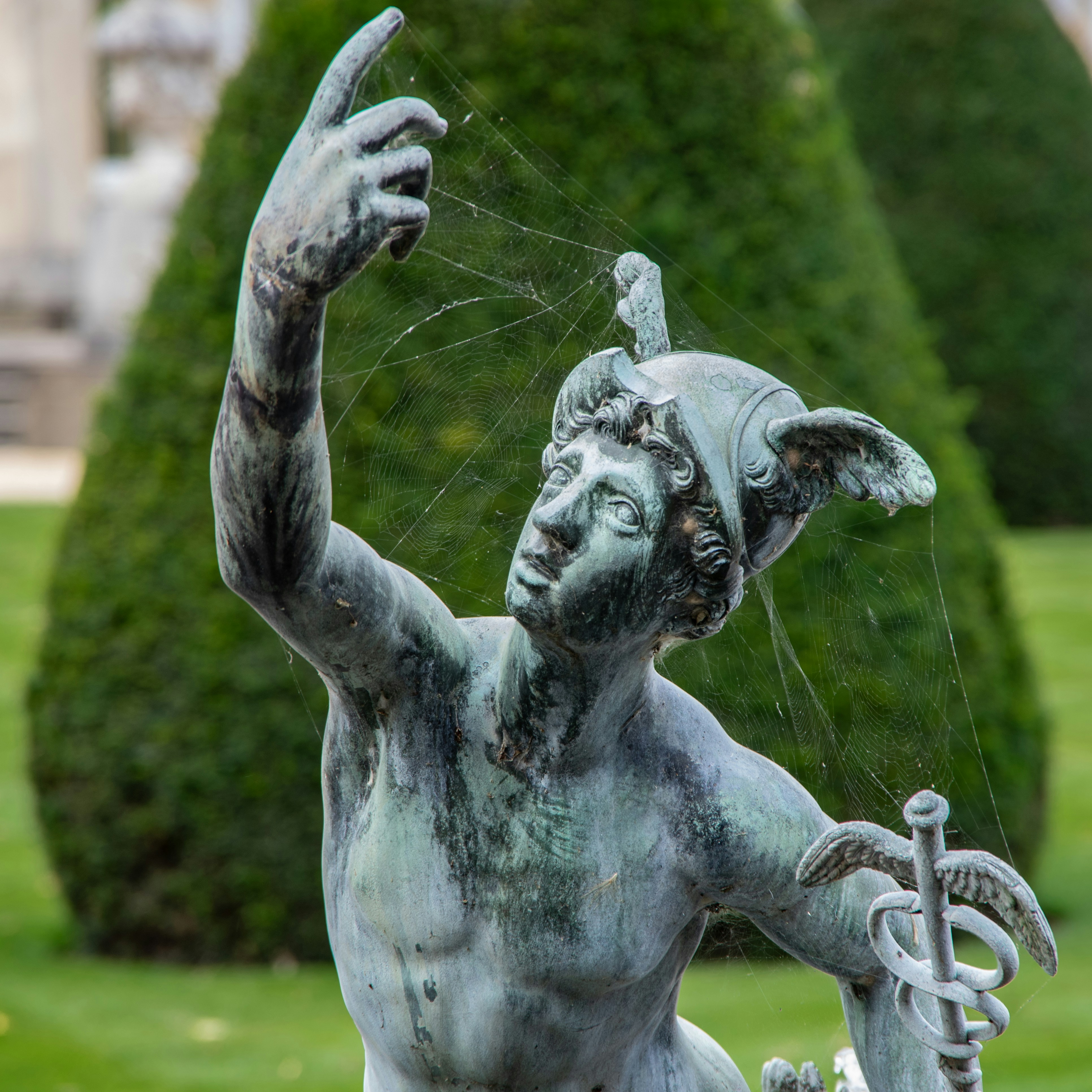 Statue of Mercury in the grounds of Syon Park, covered in cobwebs.