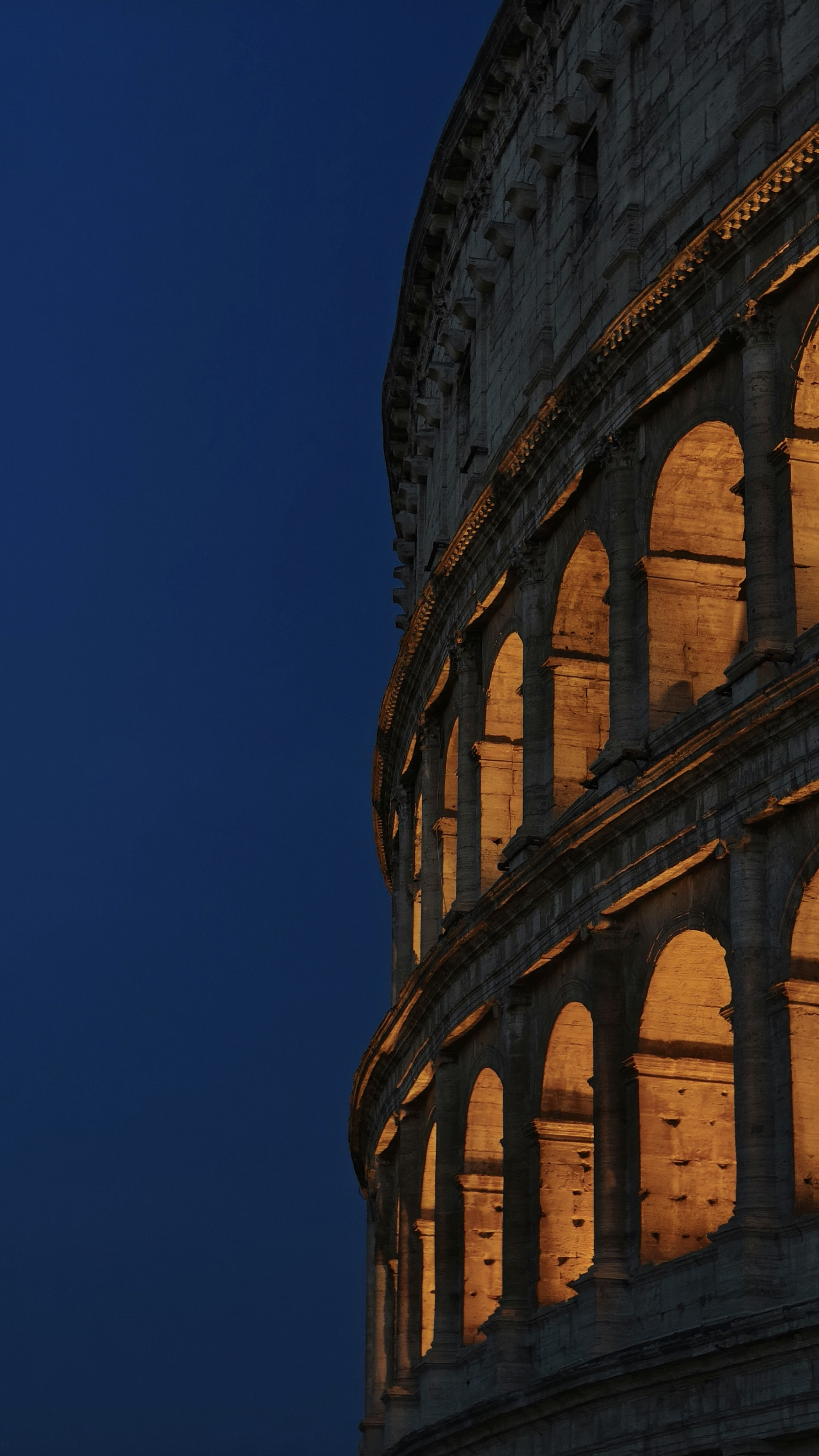 Illuminated Arc: Nighttime Colosseum Curves in Warm Light