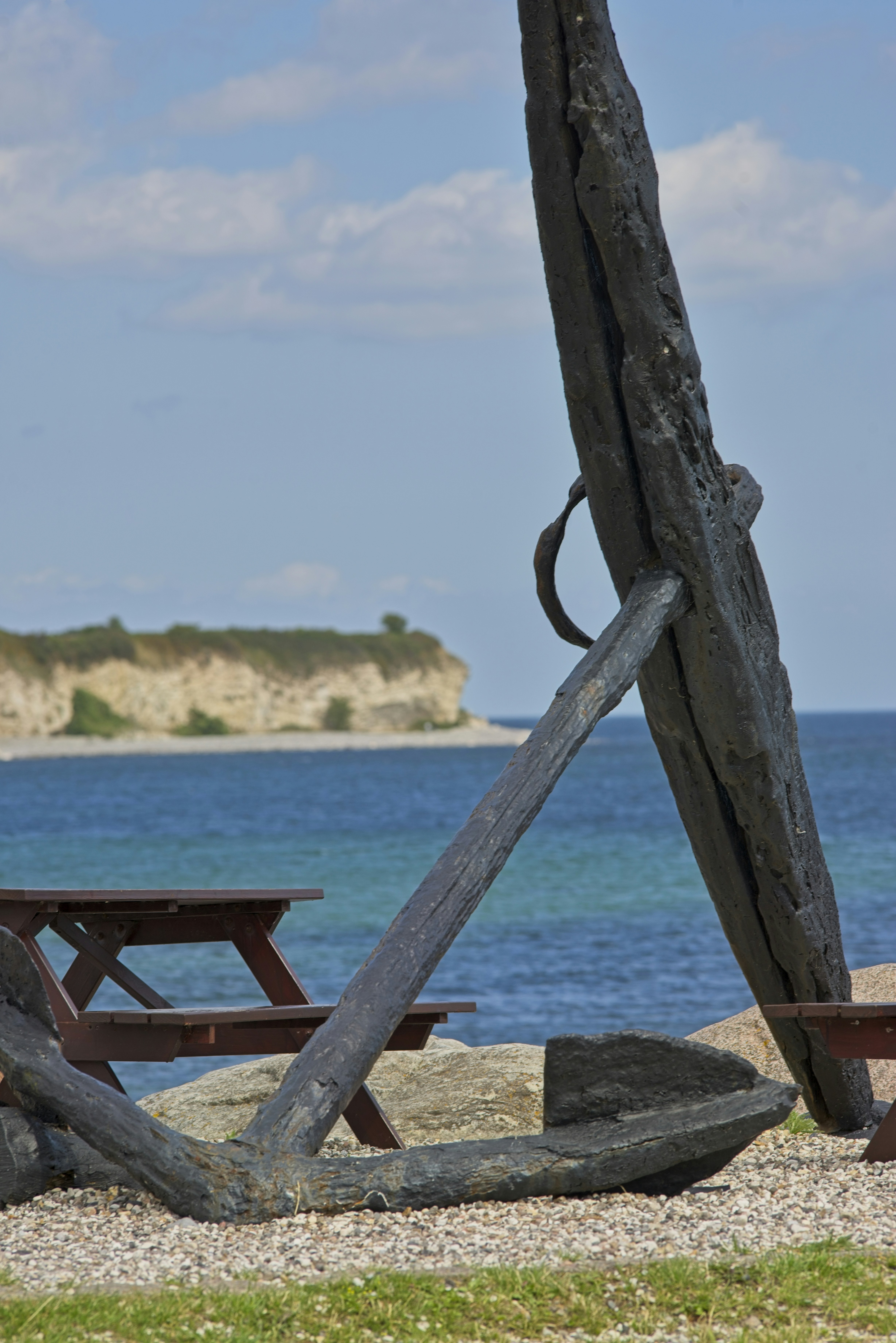 Weathered Timber by the Sea: A Quiet Moment on the Pebble Shore