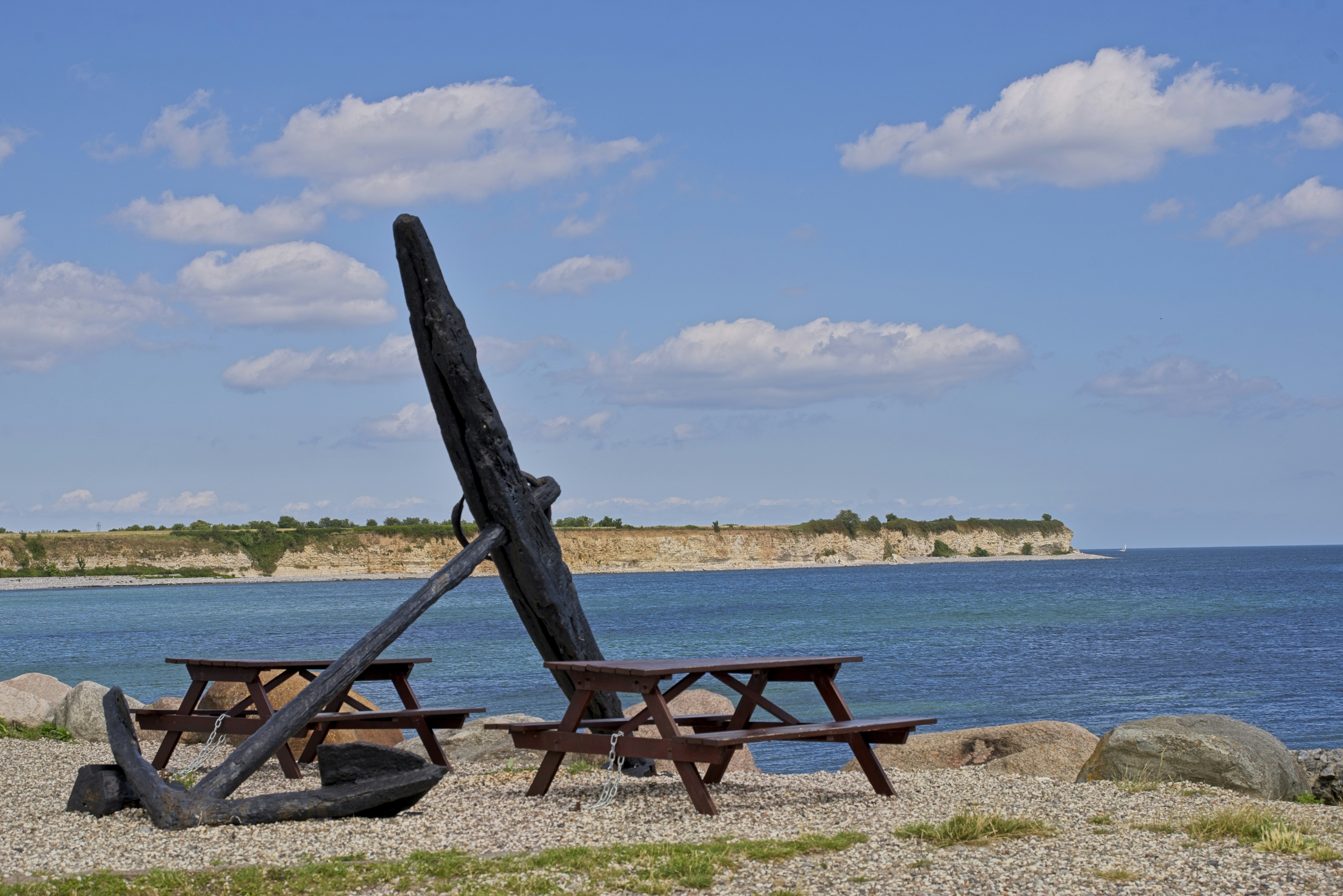 Sunlit Sea Terrace: Weathered wood and tranquil blue horizon