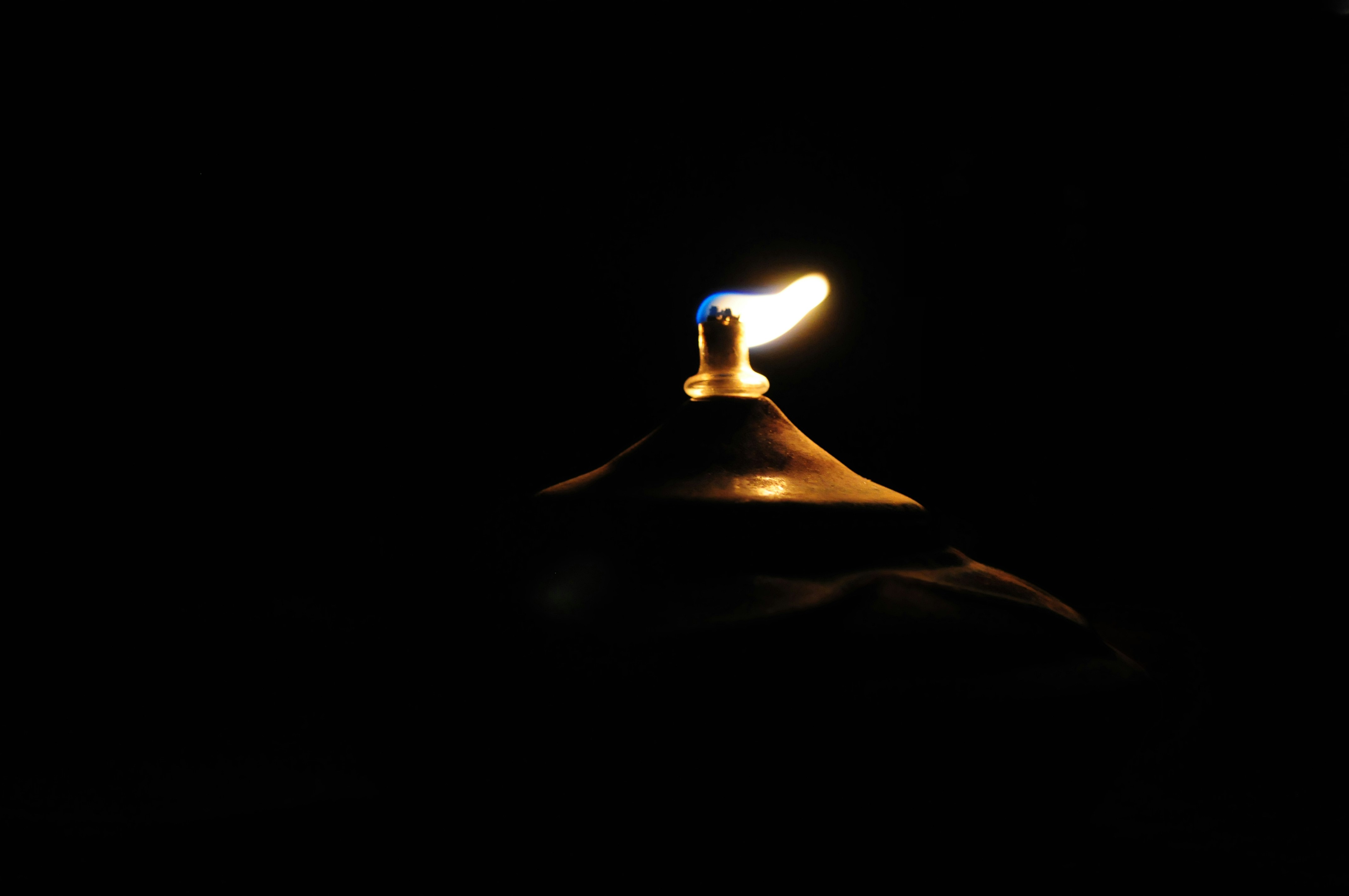 Single Flame, Silent Peak: A Dim Portrait of a Lighter