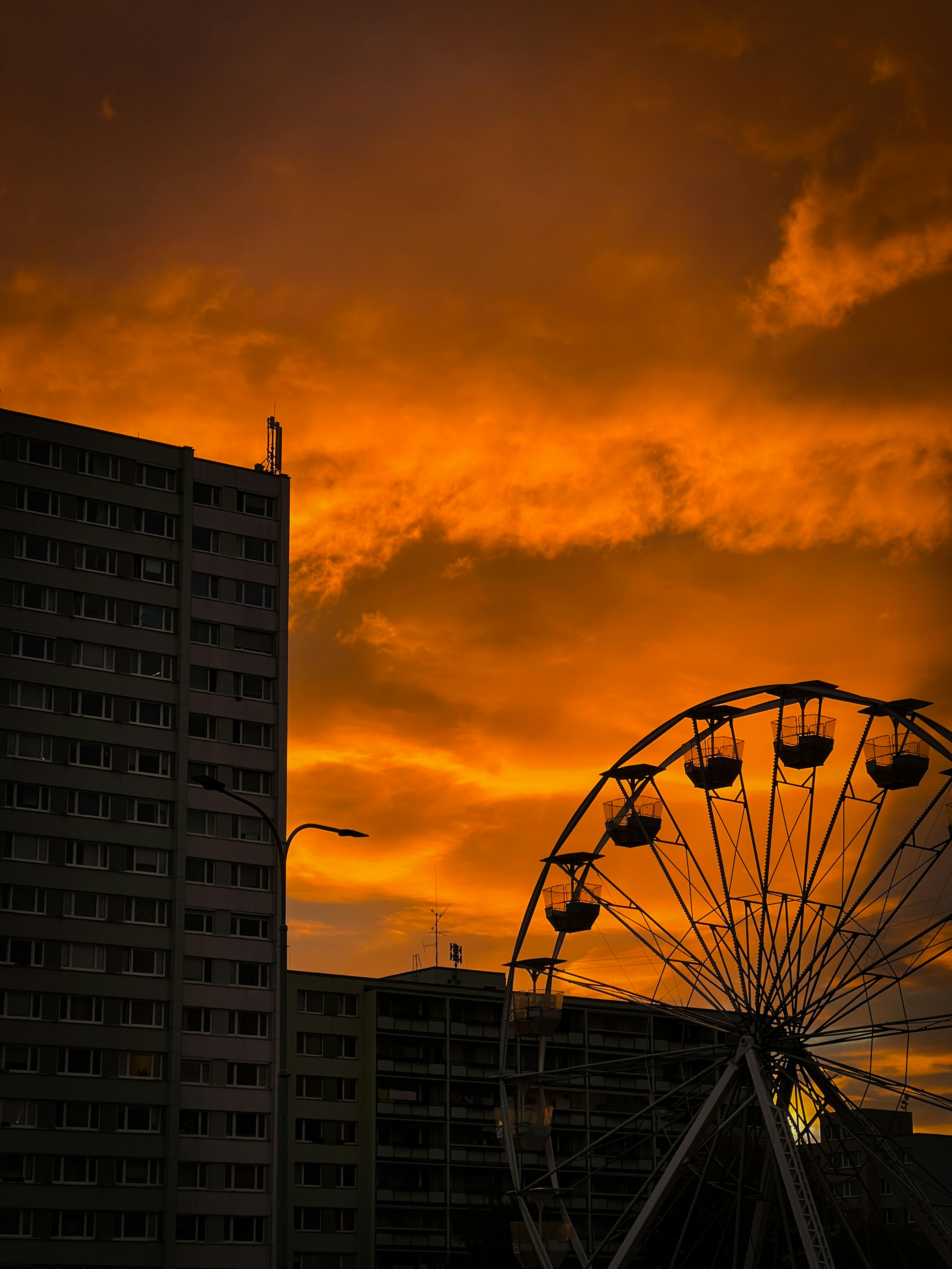 Ferris Wheel at Orange Hour: Urban Skyline in Sunset