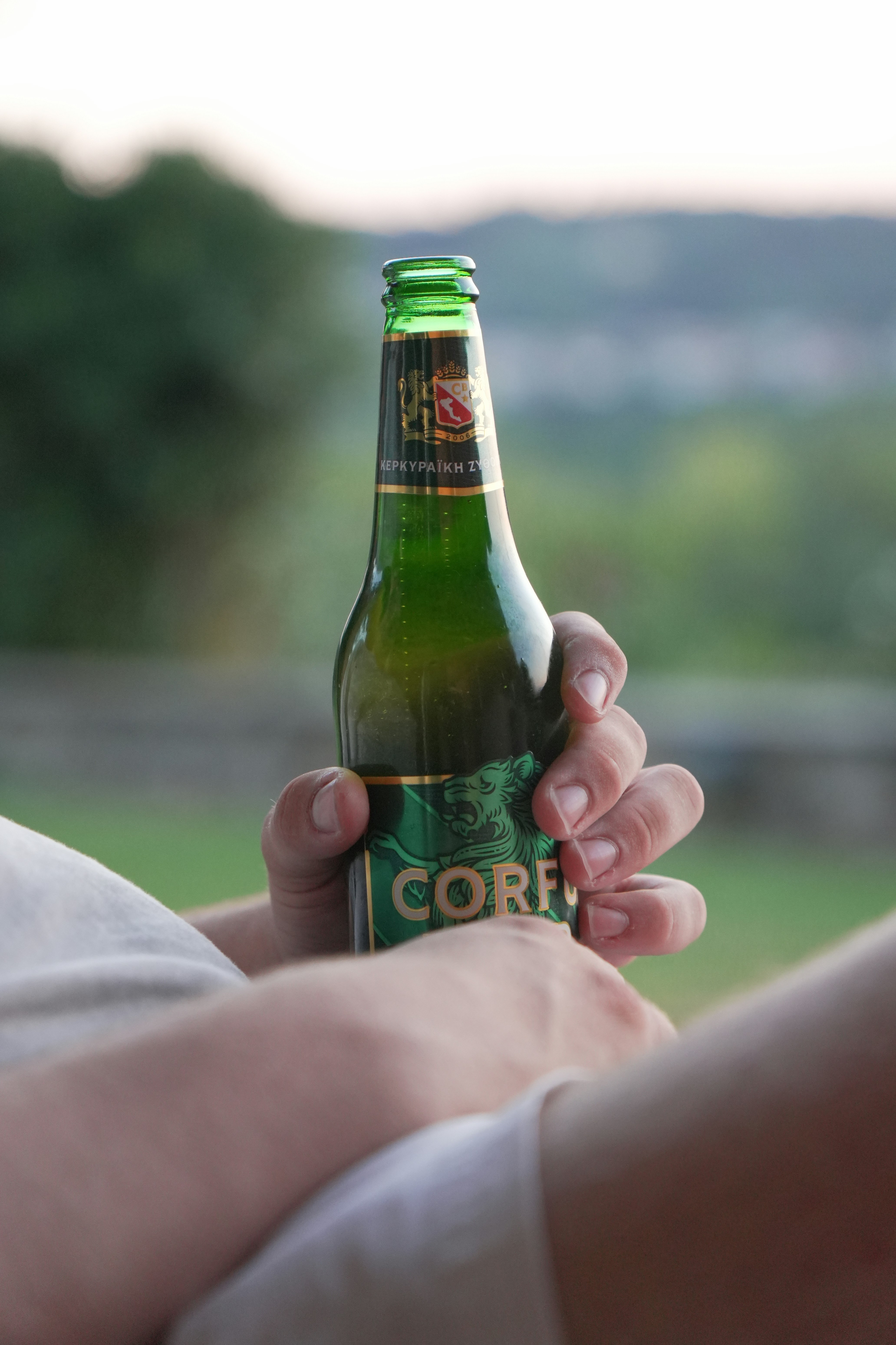 Handful of Cheer: A Bottle Gripped in Focus