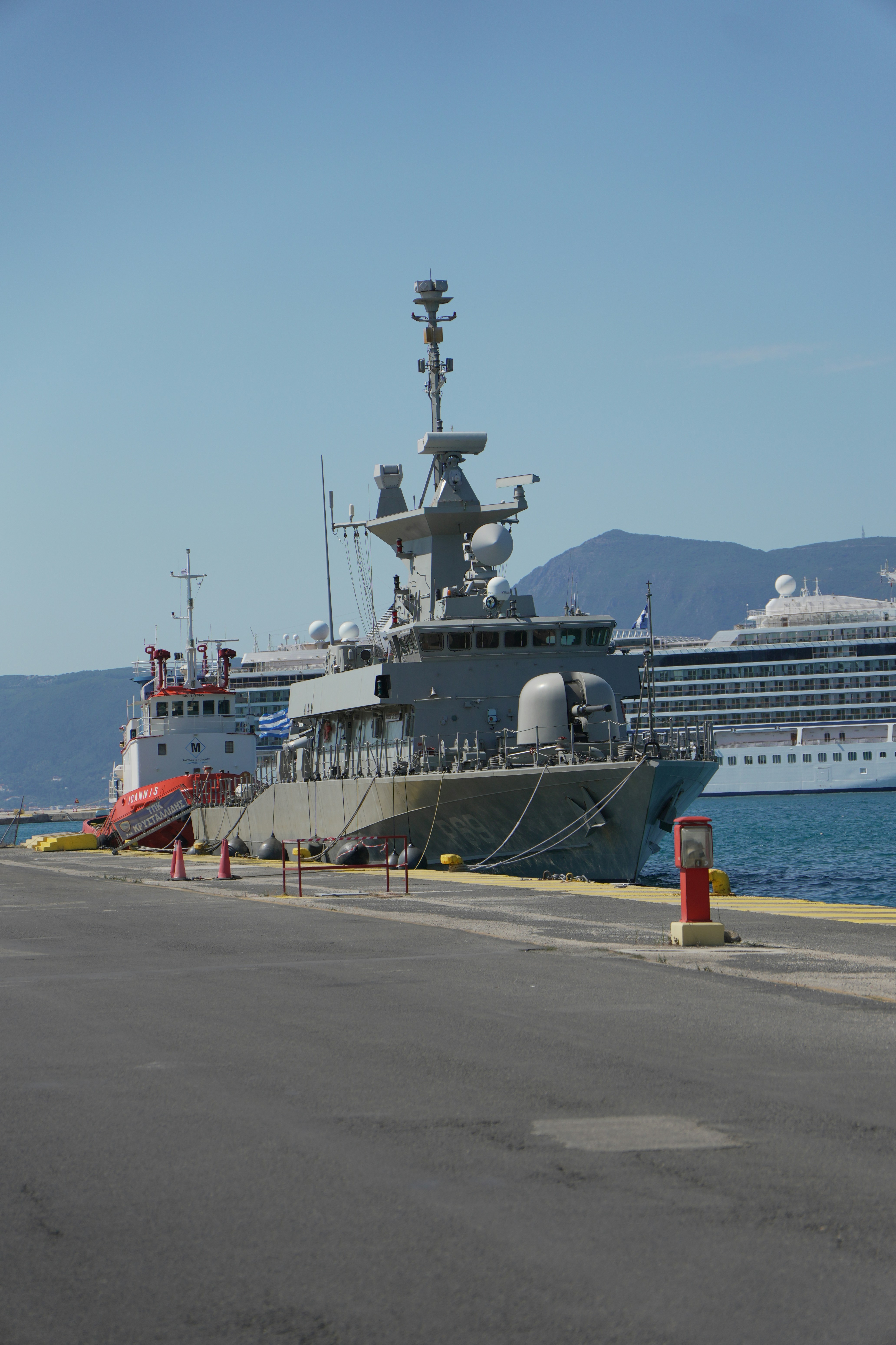 Harbor Sentinel: A naval vessel at port under clear skies