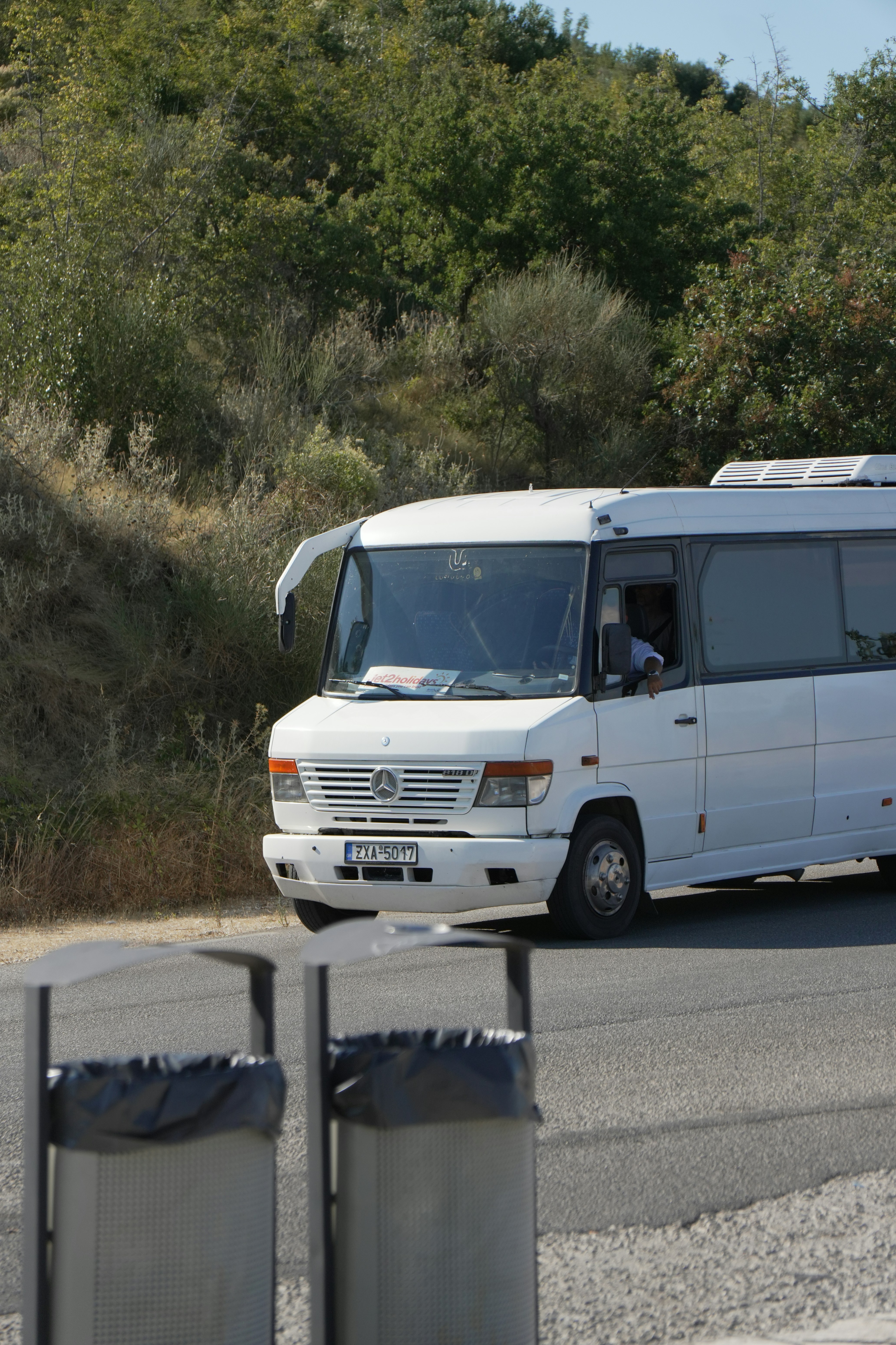 White Van on a Winding Road: A Quiet Bus Moment