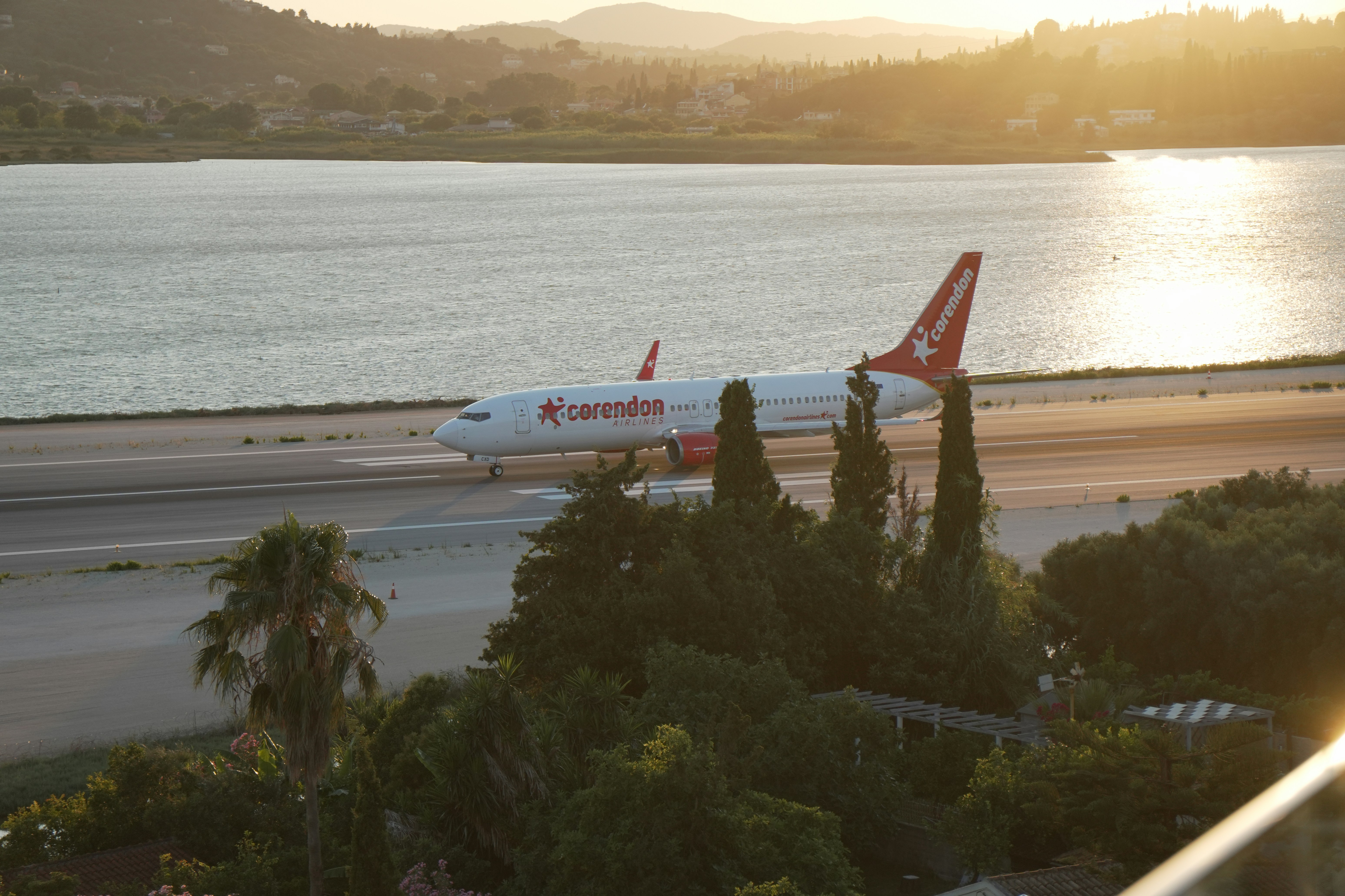 Sunlit touchdown: a corendon jet glides along the coastal runway