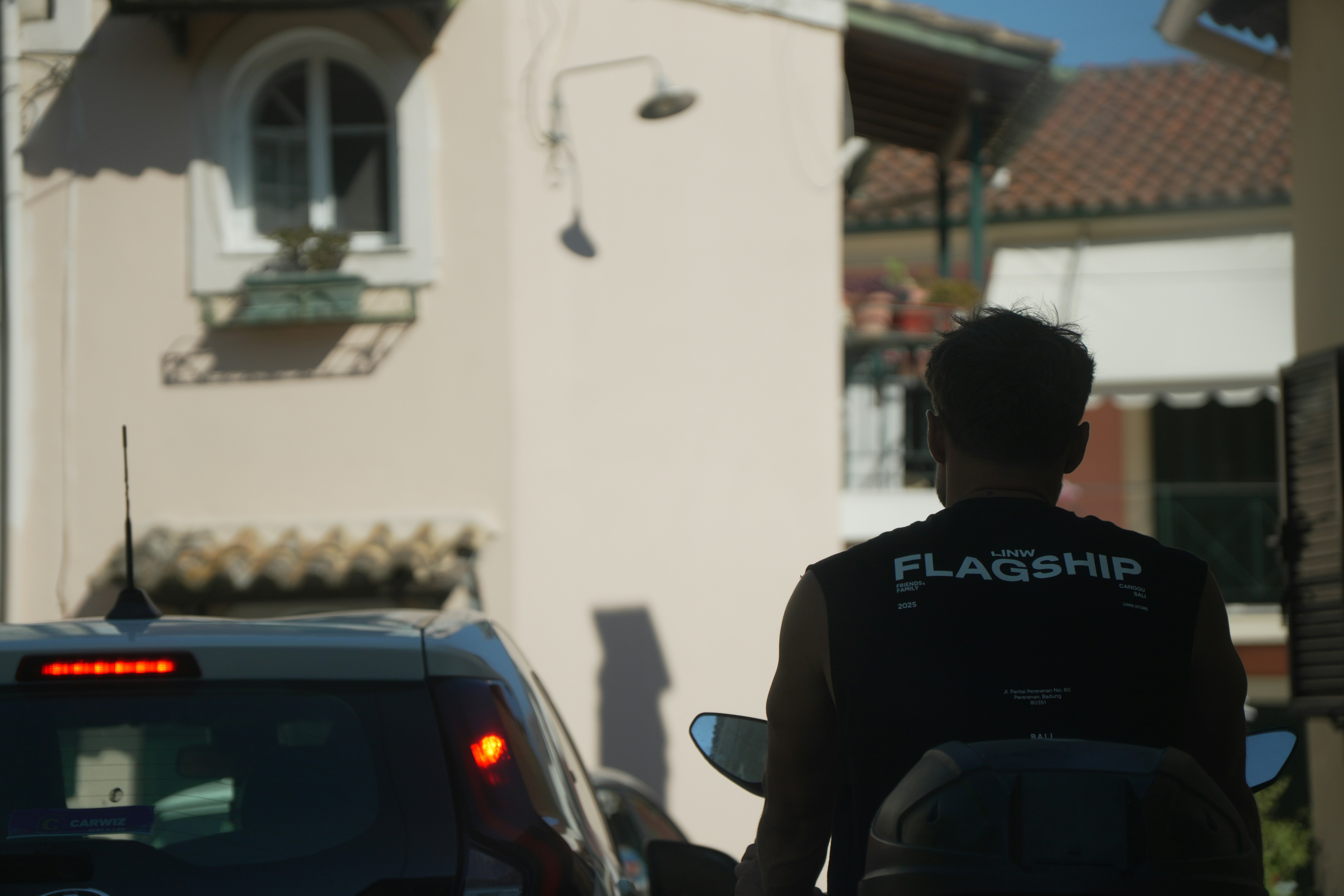 Motorcycle Club Rider in Shadow by Mediterranean Street