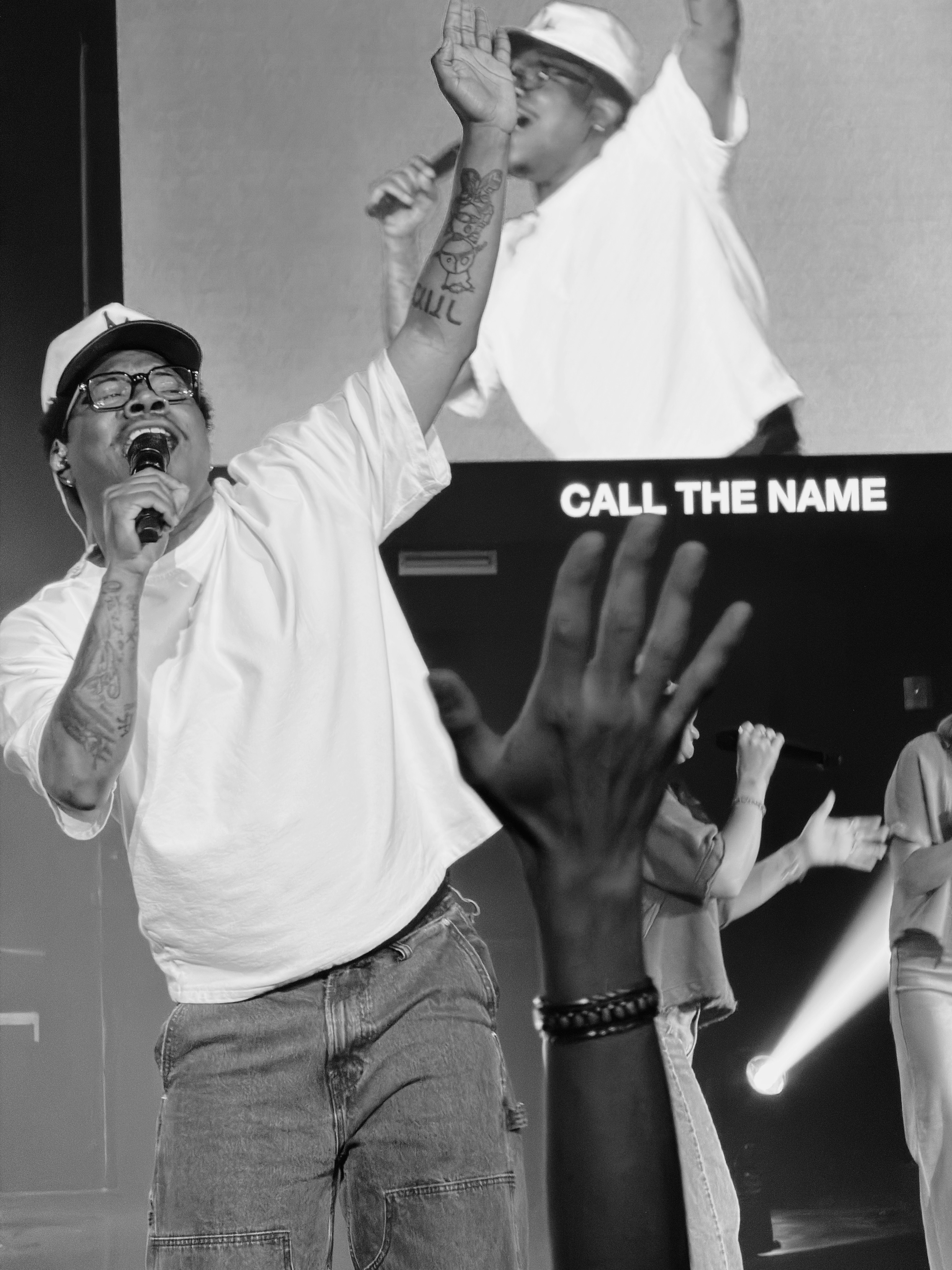 High-Energy Stage Moment: Lead Singer Reaches Out Amidst Crowd