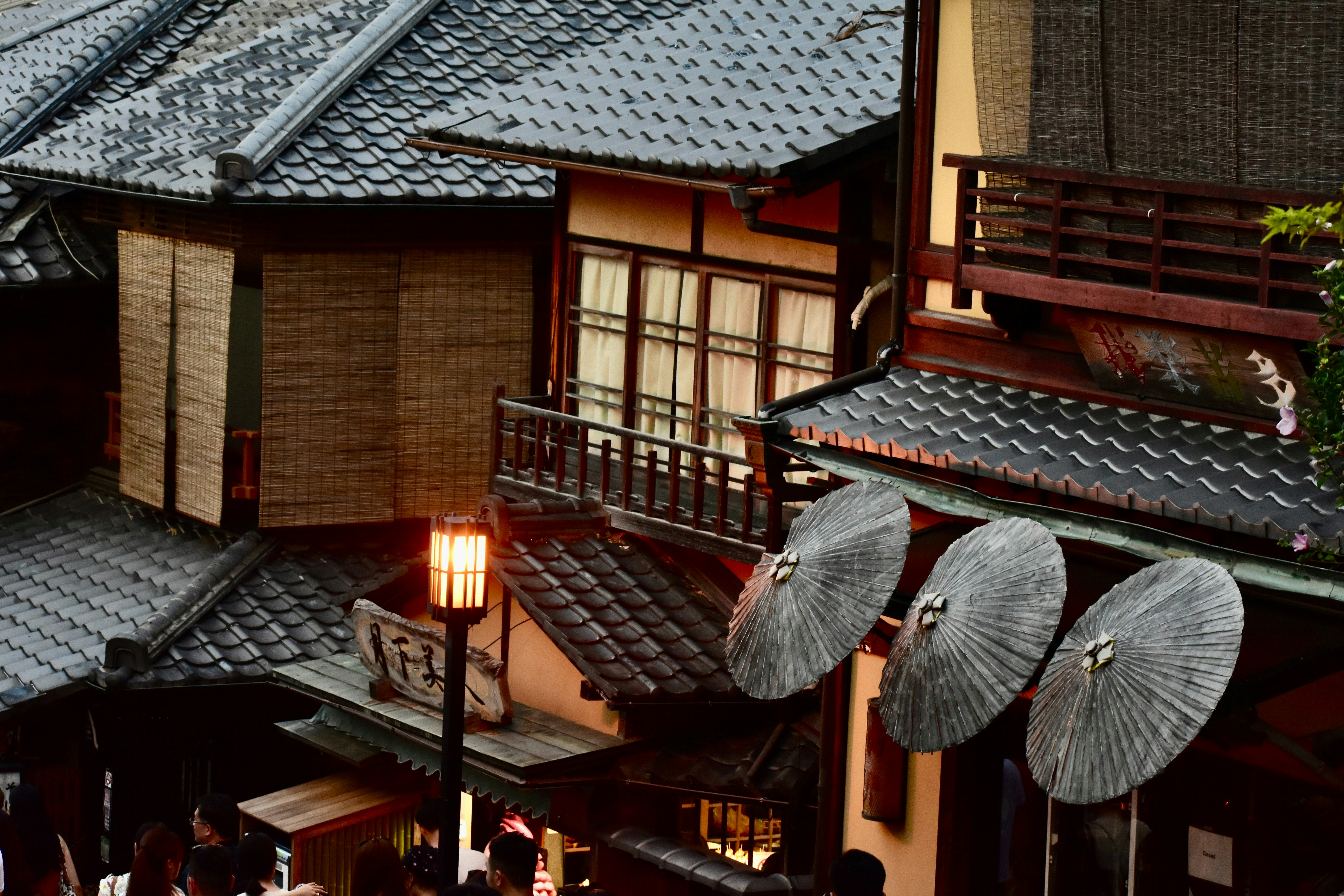 Lanterns and Umbrellas Over a Quiet Alley in a Traditional Street