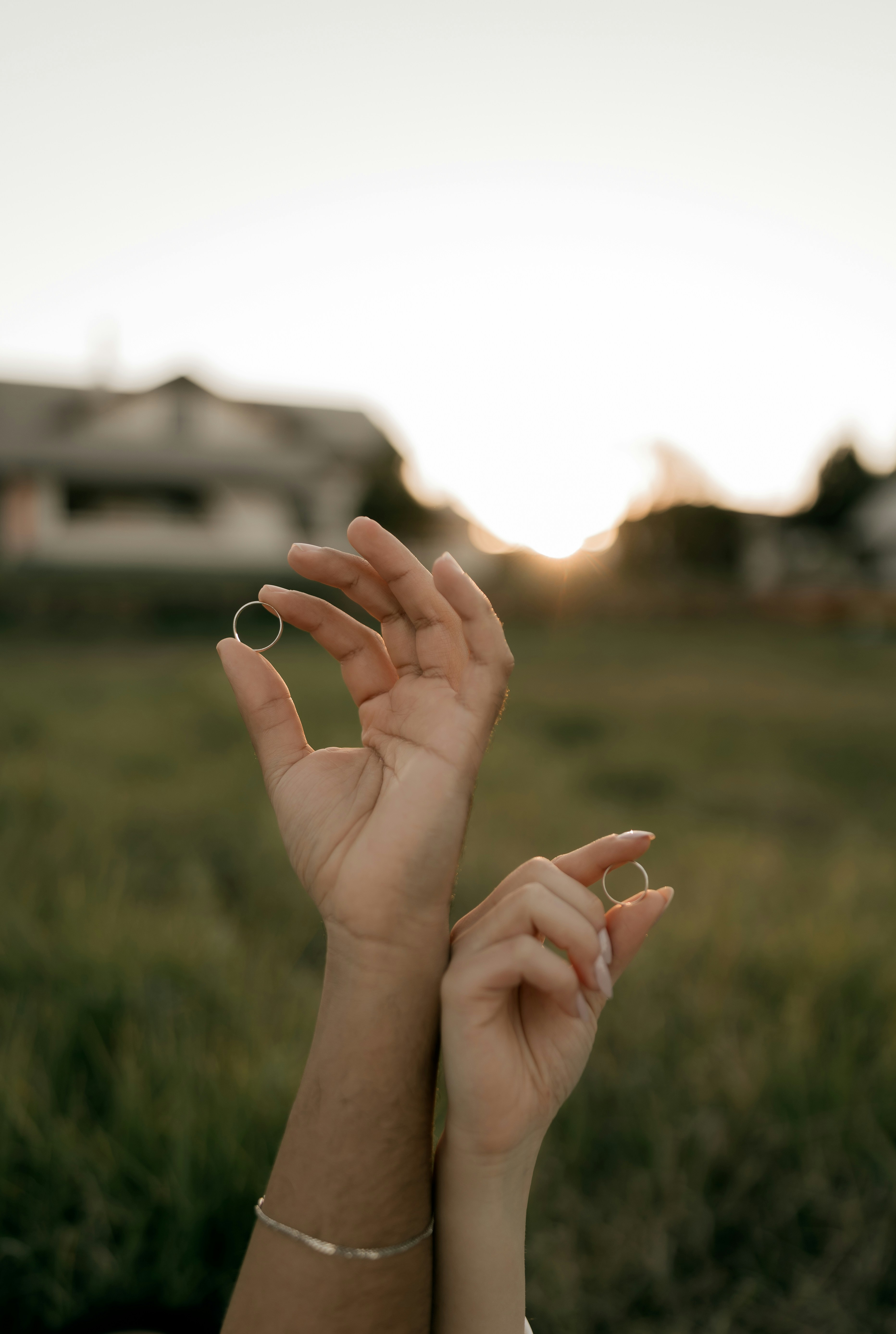 Holding Moon Rings: Delicate Hands Framing Evening Light