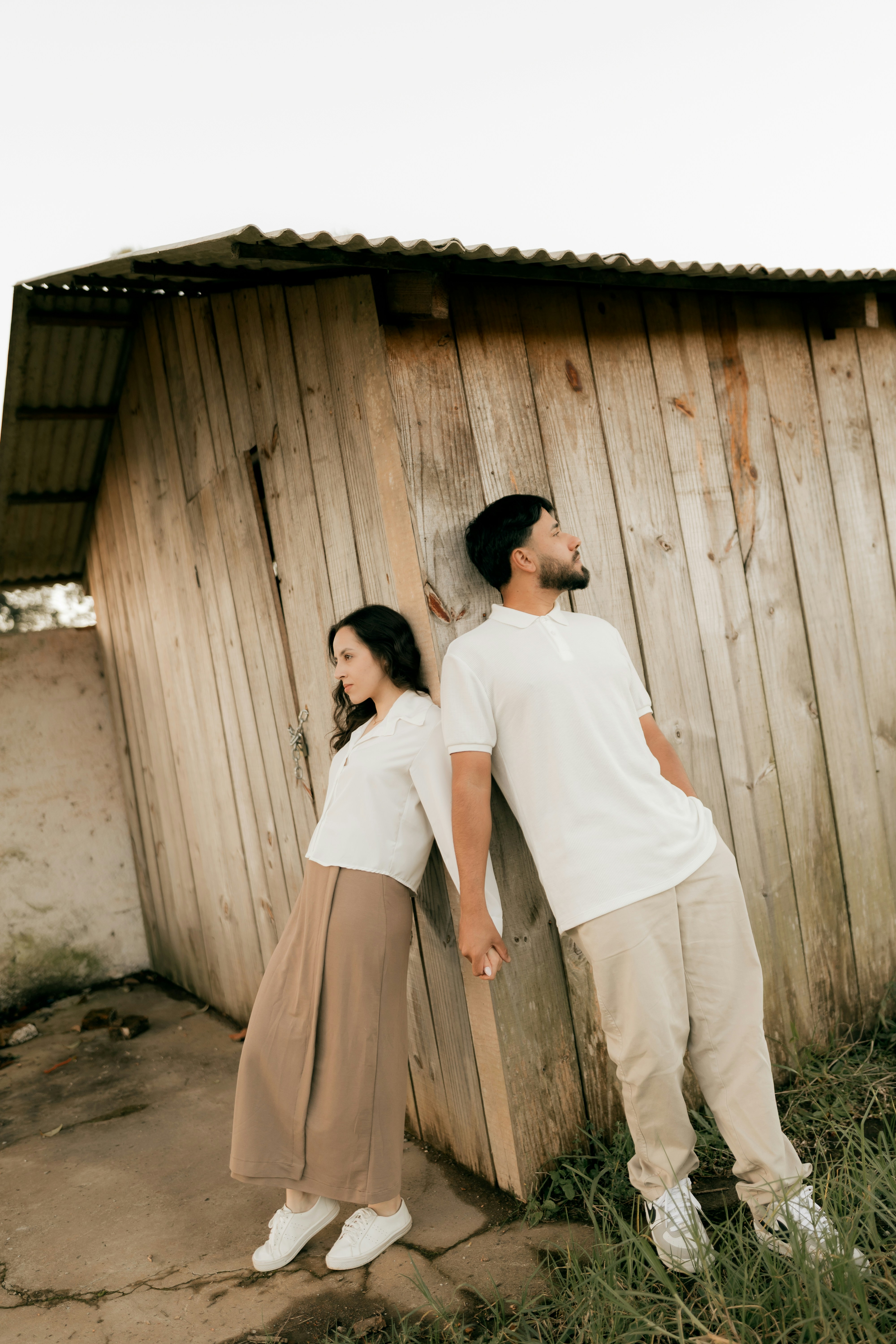 Two Quiet Souls Lean Against Weathered Wood