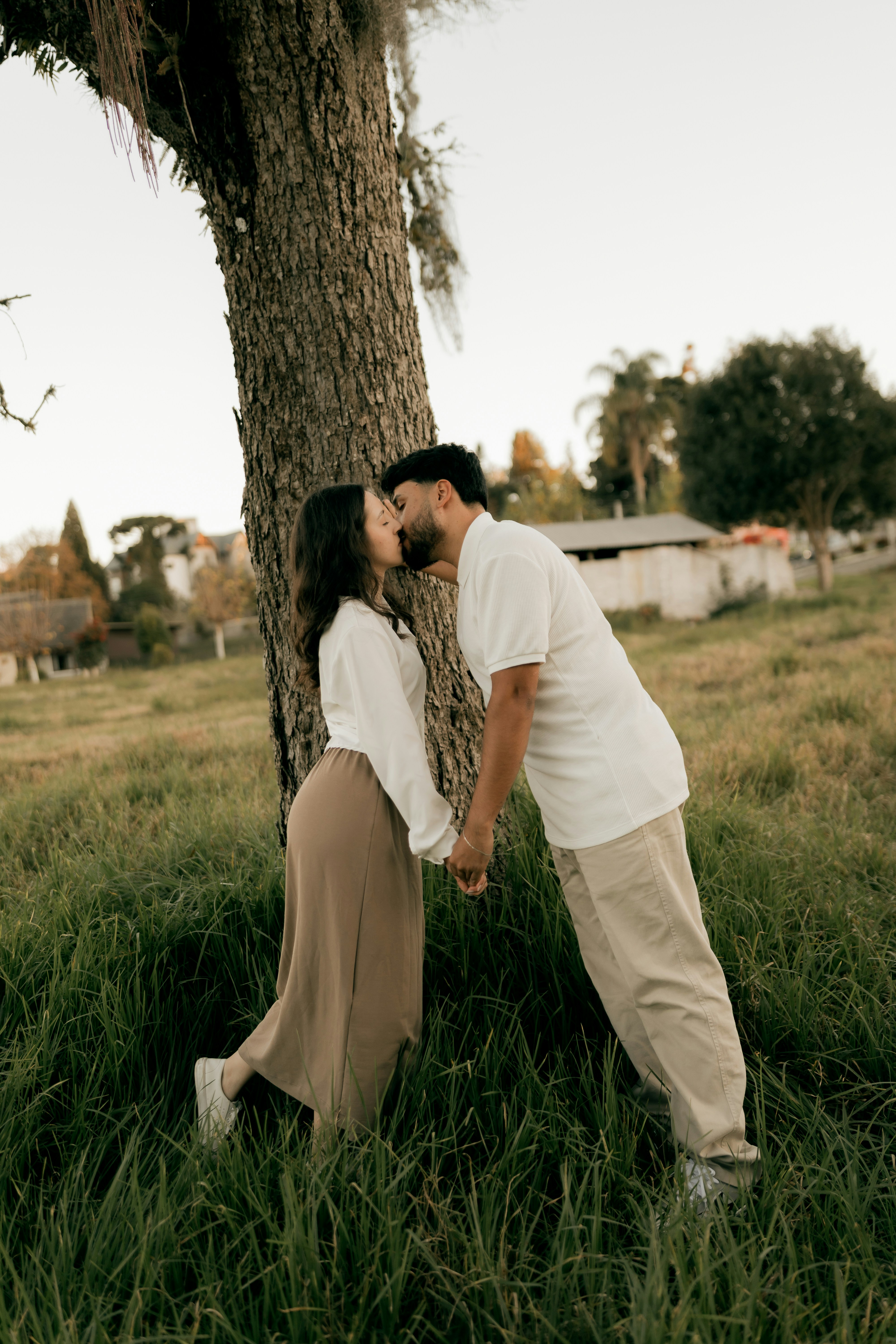 Kiss Under the Old Tree: A Quiet Moment in the Field