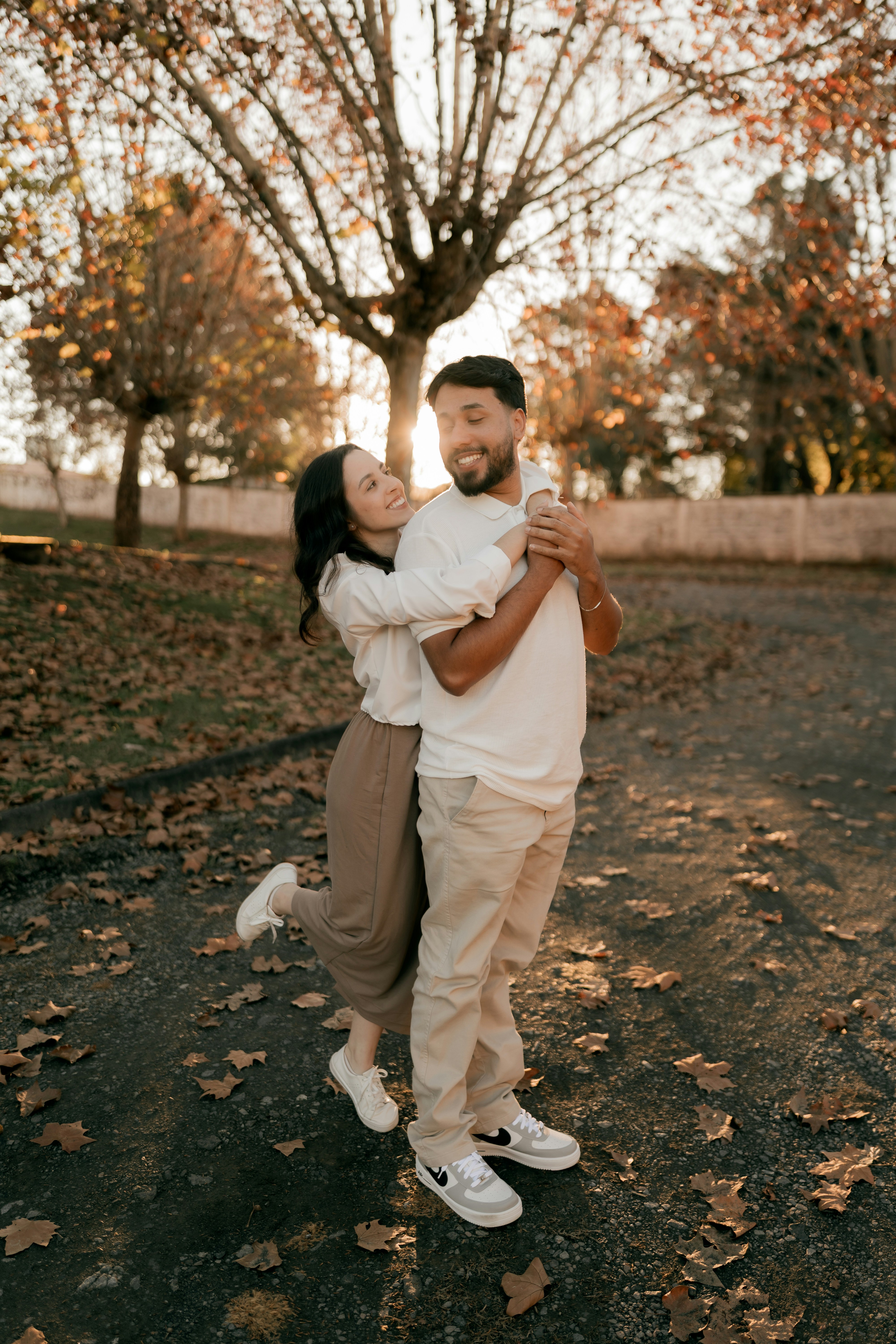 Sunlit embrace: autumn park silhouettes