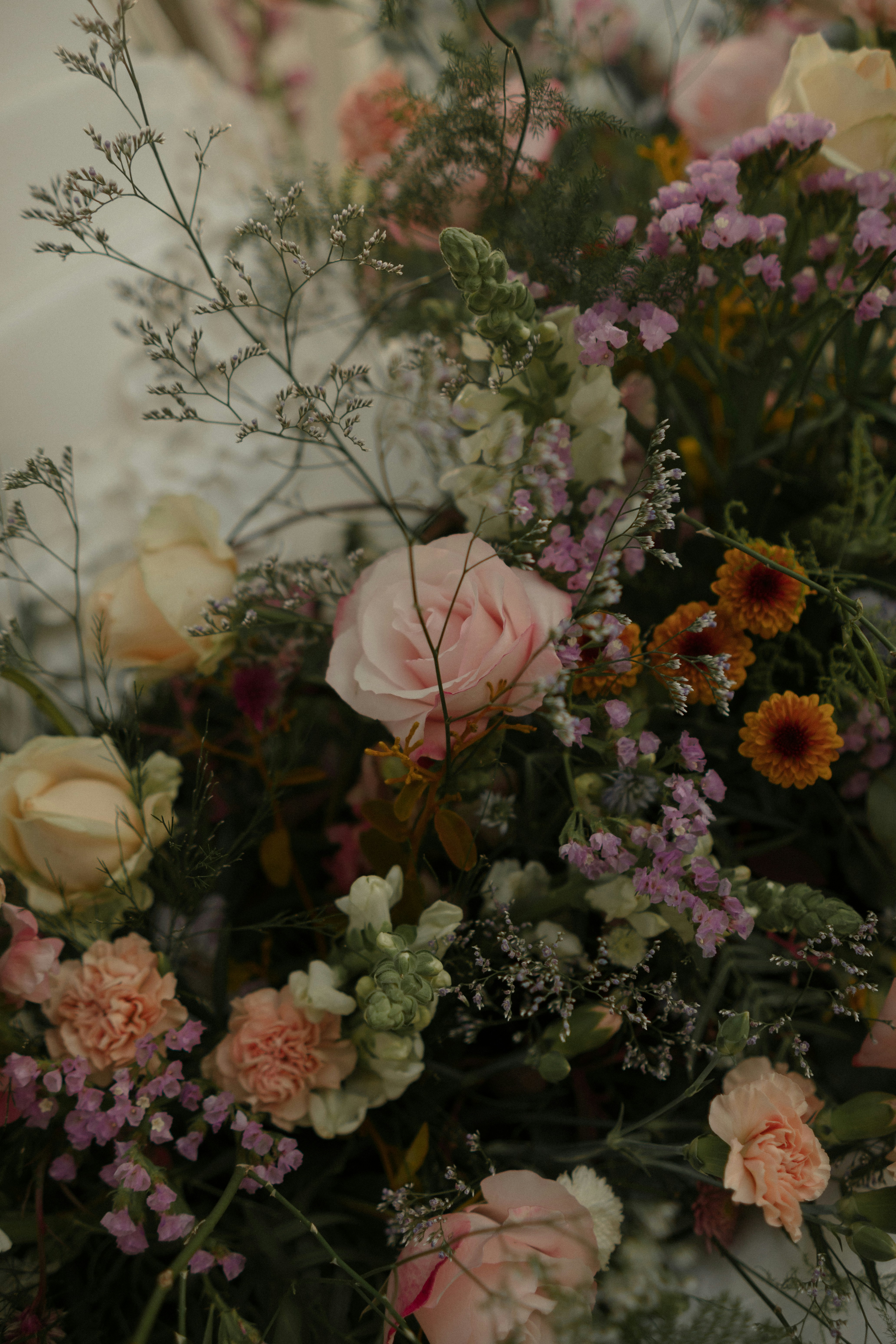 Soft-petal Symphony: A Bouquet ofPastel Roses and Wild Sprigs
