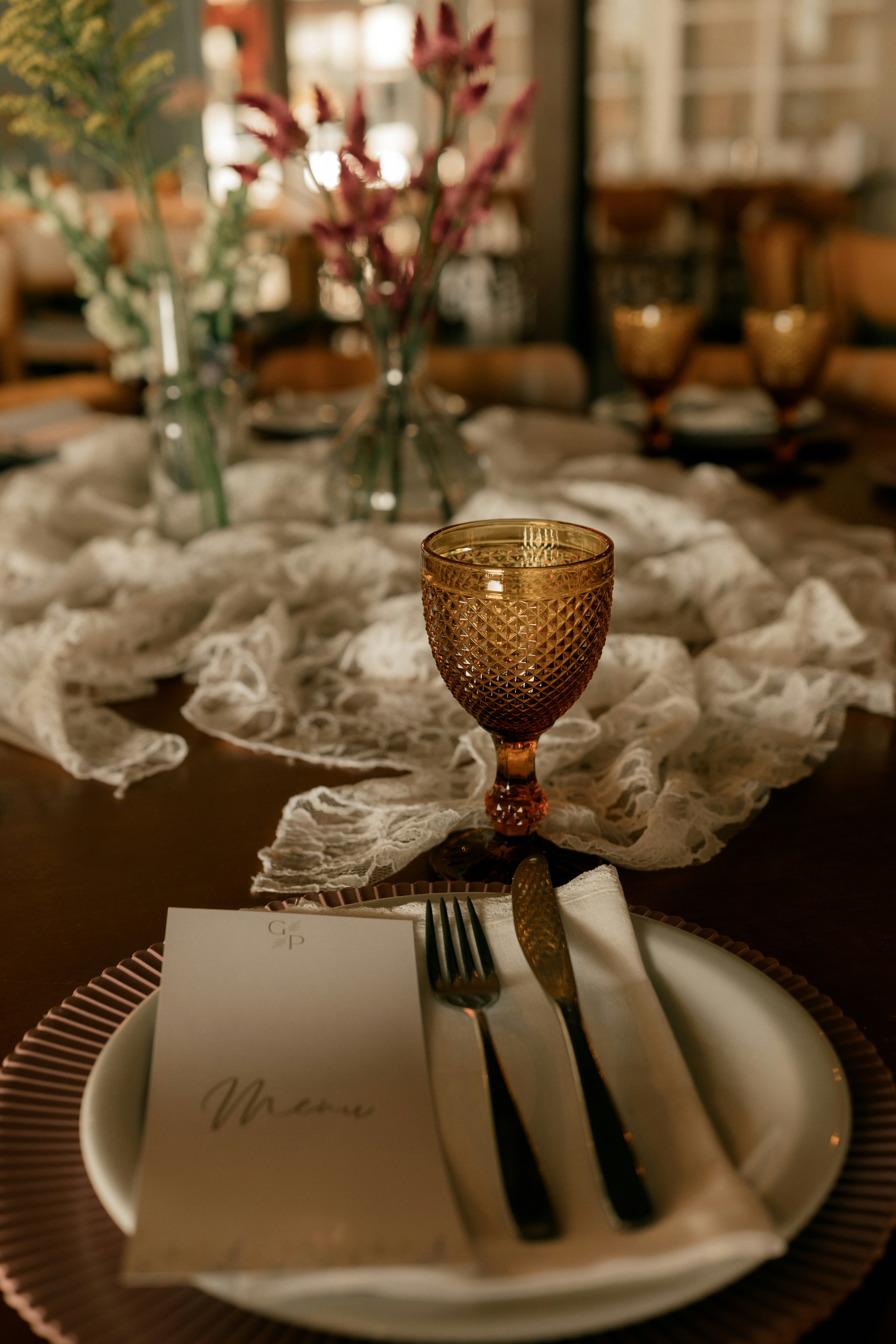 Amber Glass centerpiece on lace-draped table set for dinner