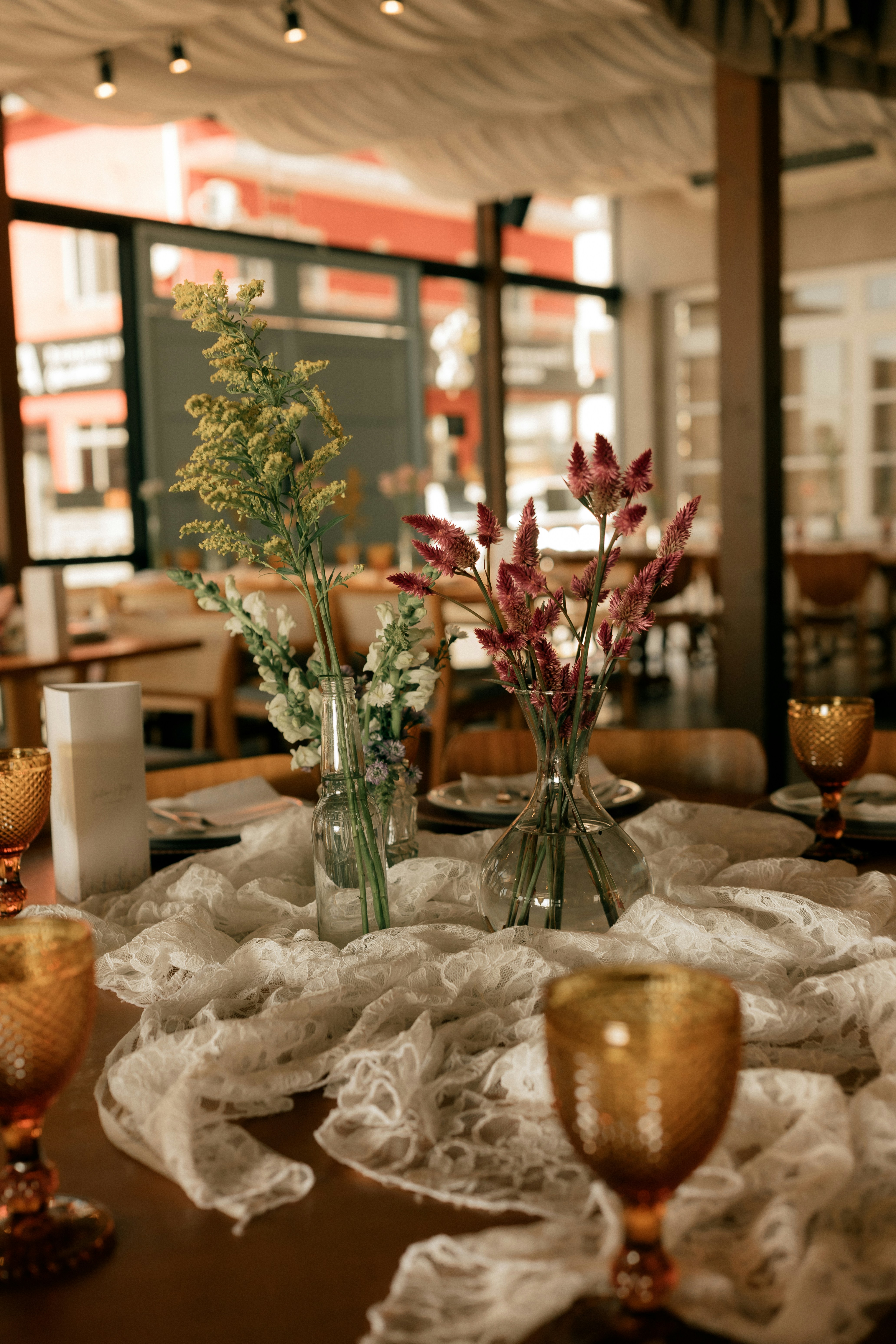 Floral Centerpiece in a warmly Set Dining Hall