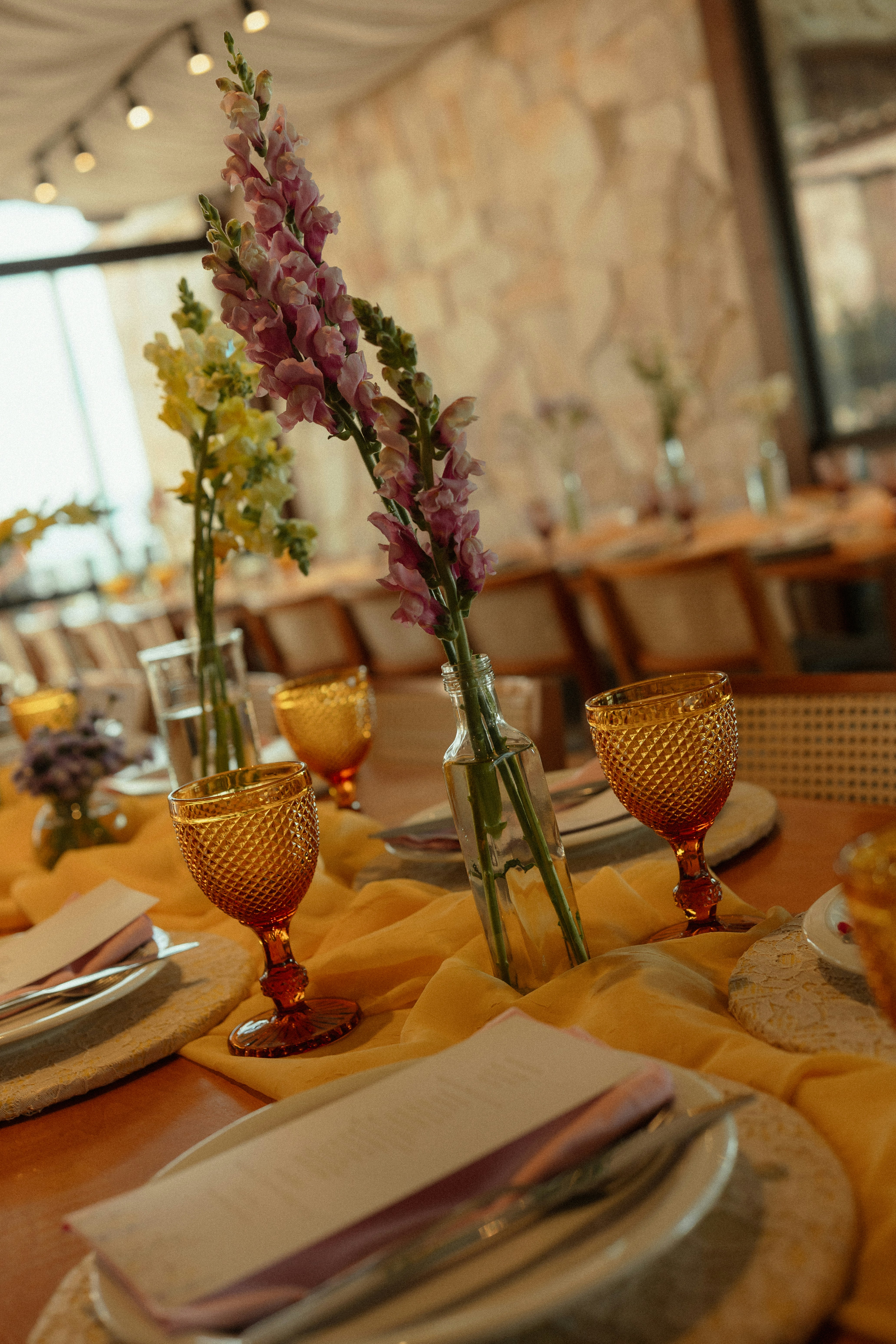 Floral centerpiece under warm ambient lighting at a banquet table