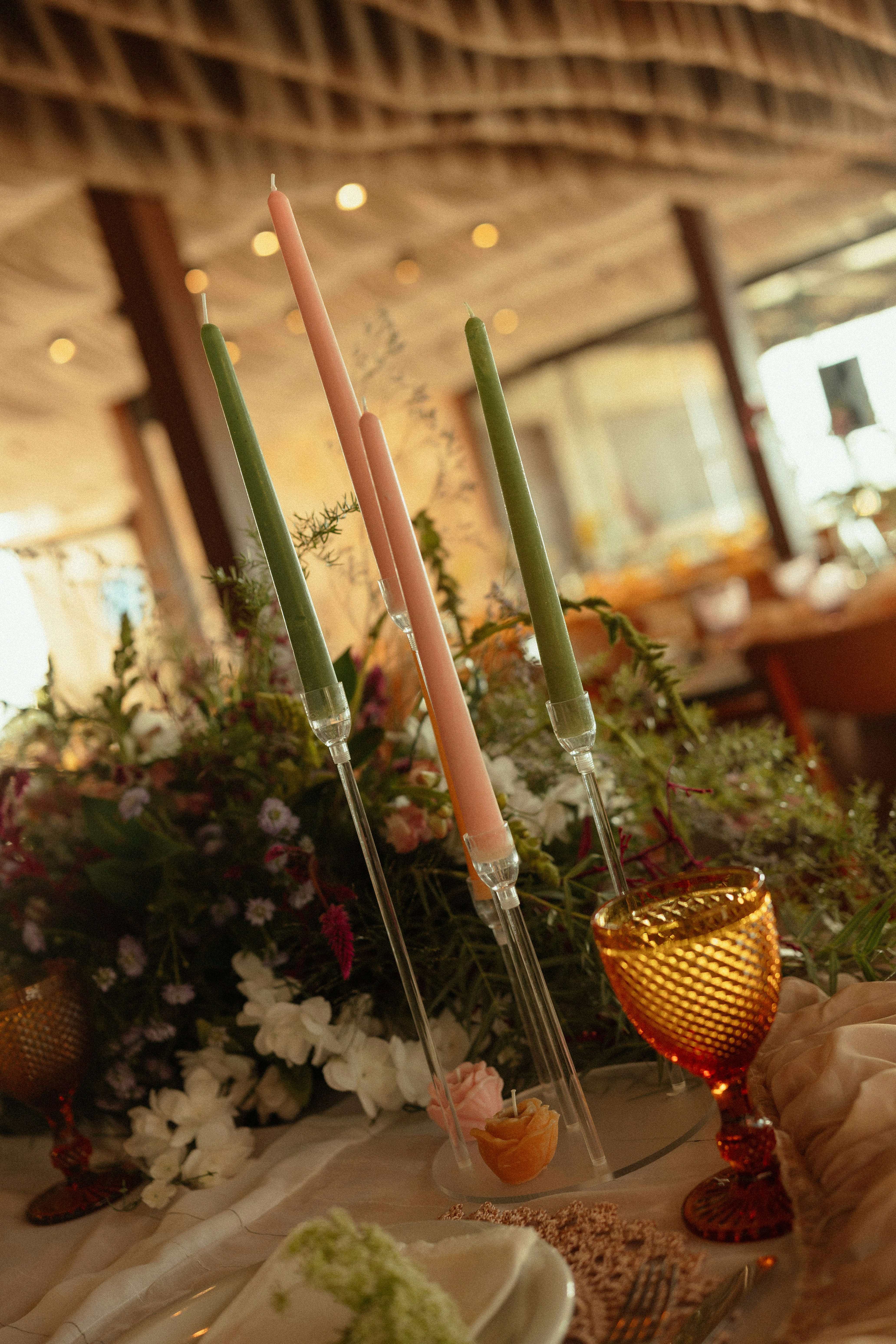 Candles in Bloom: Elegant Tabletop Moment Amid Soft Bistro Light