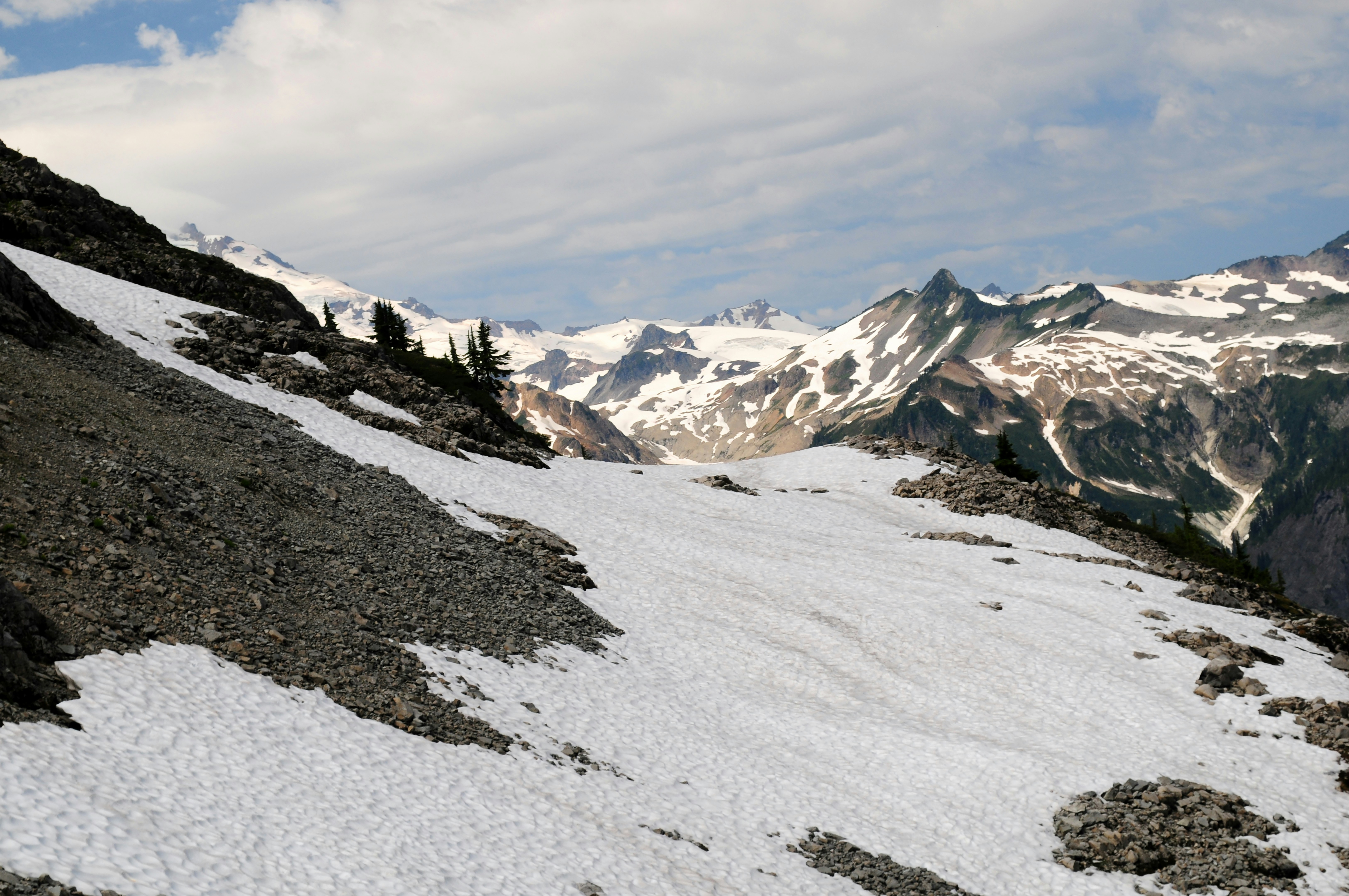 Snow-draped ridgeline beneath a bright alpine sky