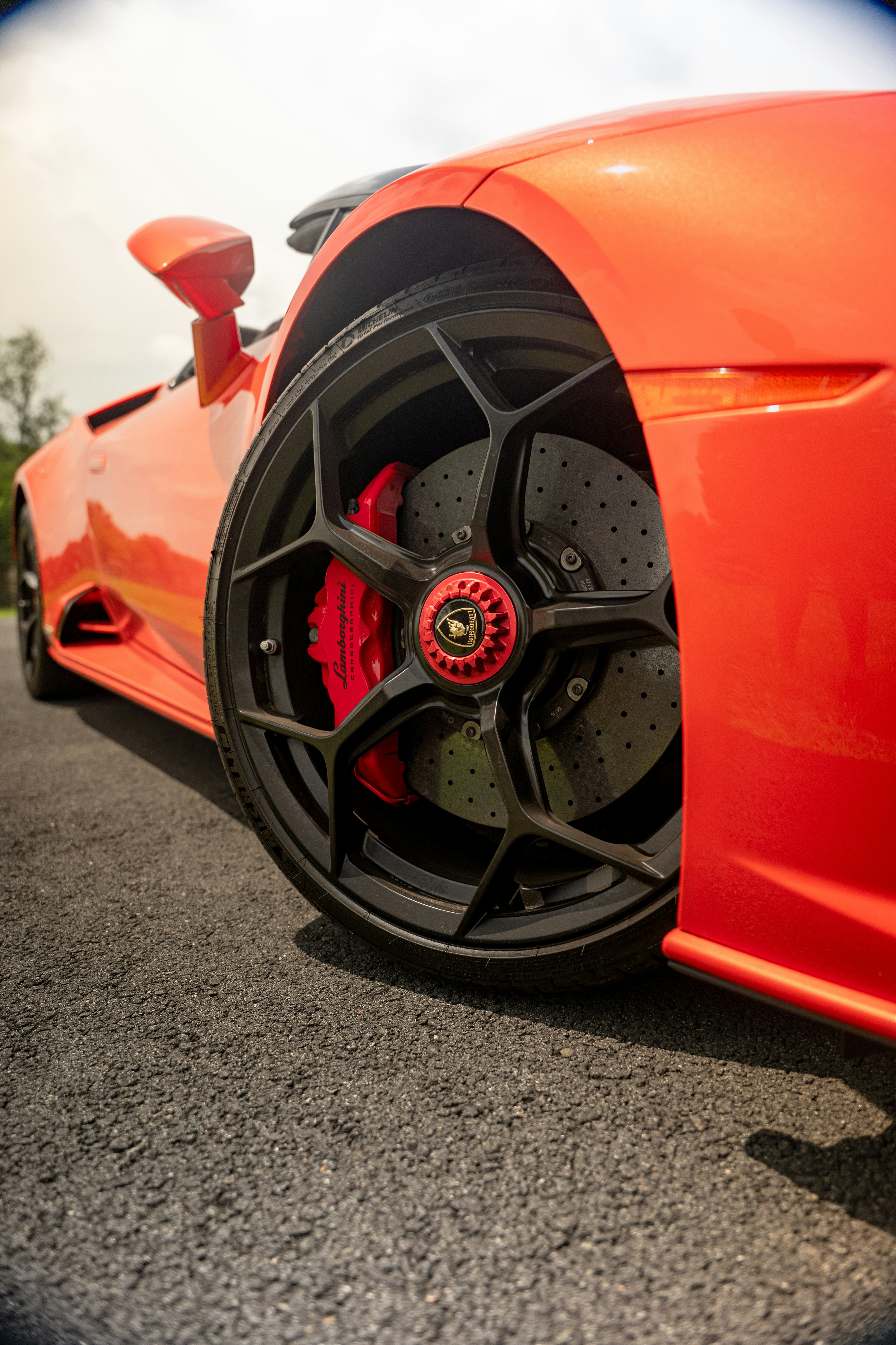 Red Alloy Command: A Low-Angle Glimpse of a Front-Quarter Exemplar