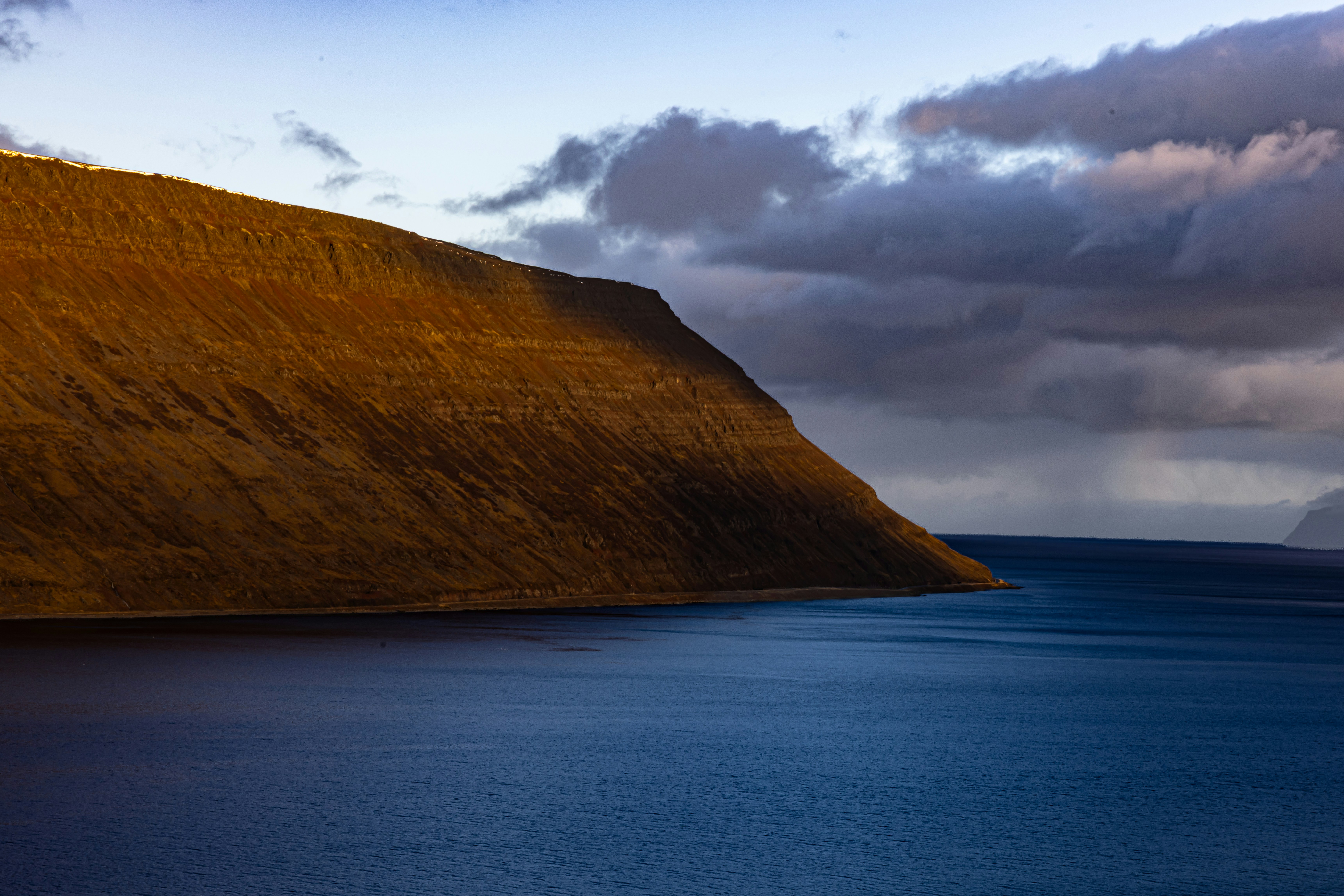 Golden Cliff Meeting the Quiet Sea