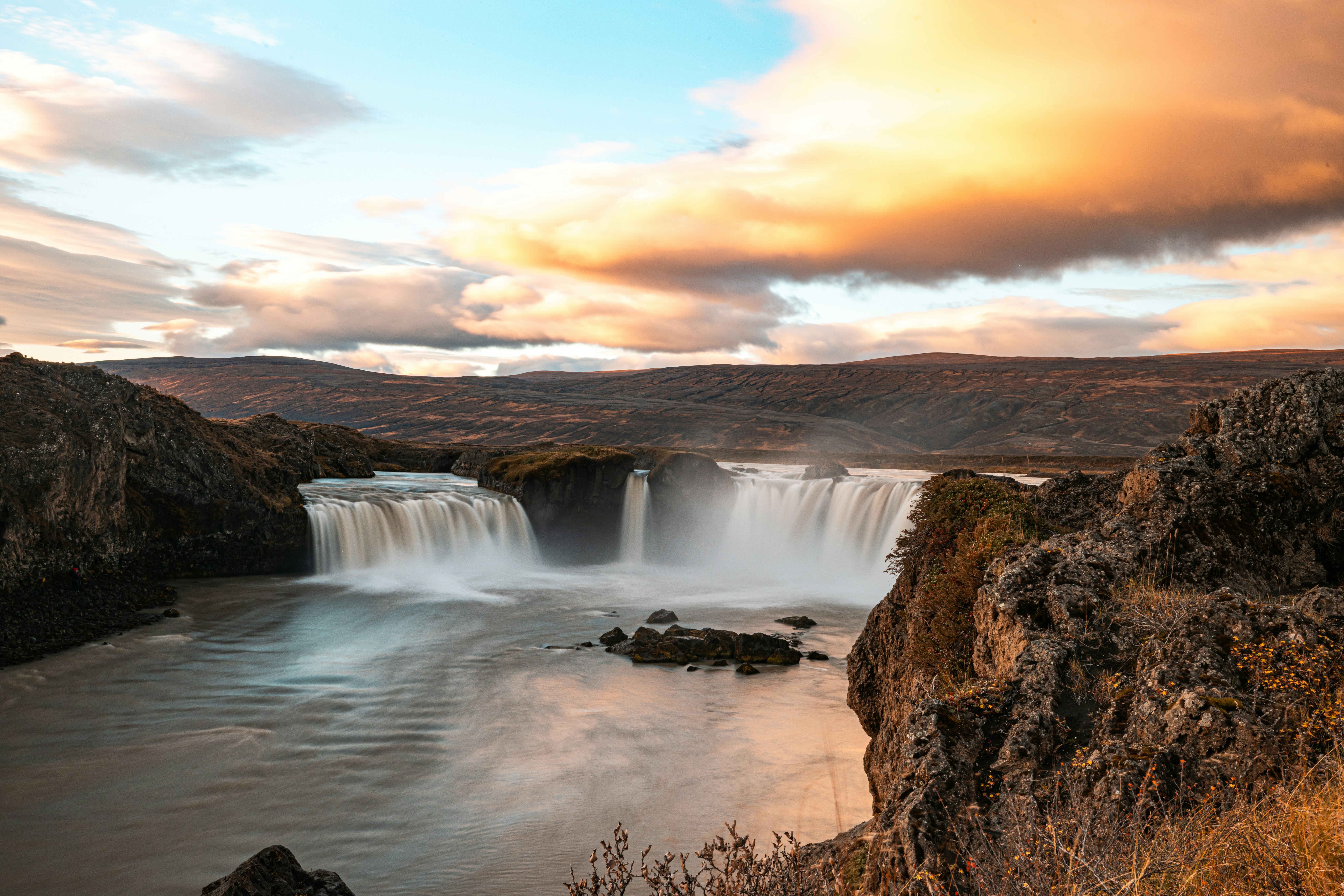 Firelit Falls: Dawn Light Over a Rugged Canyon