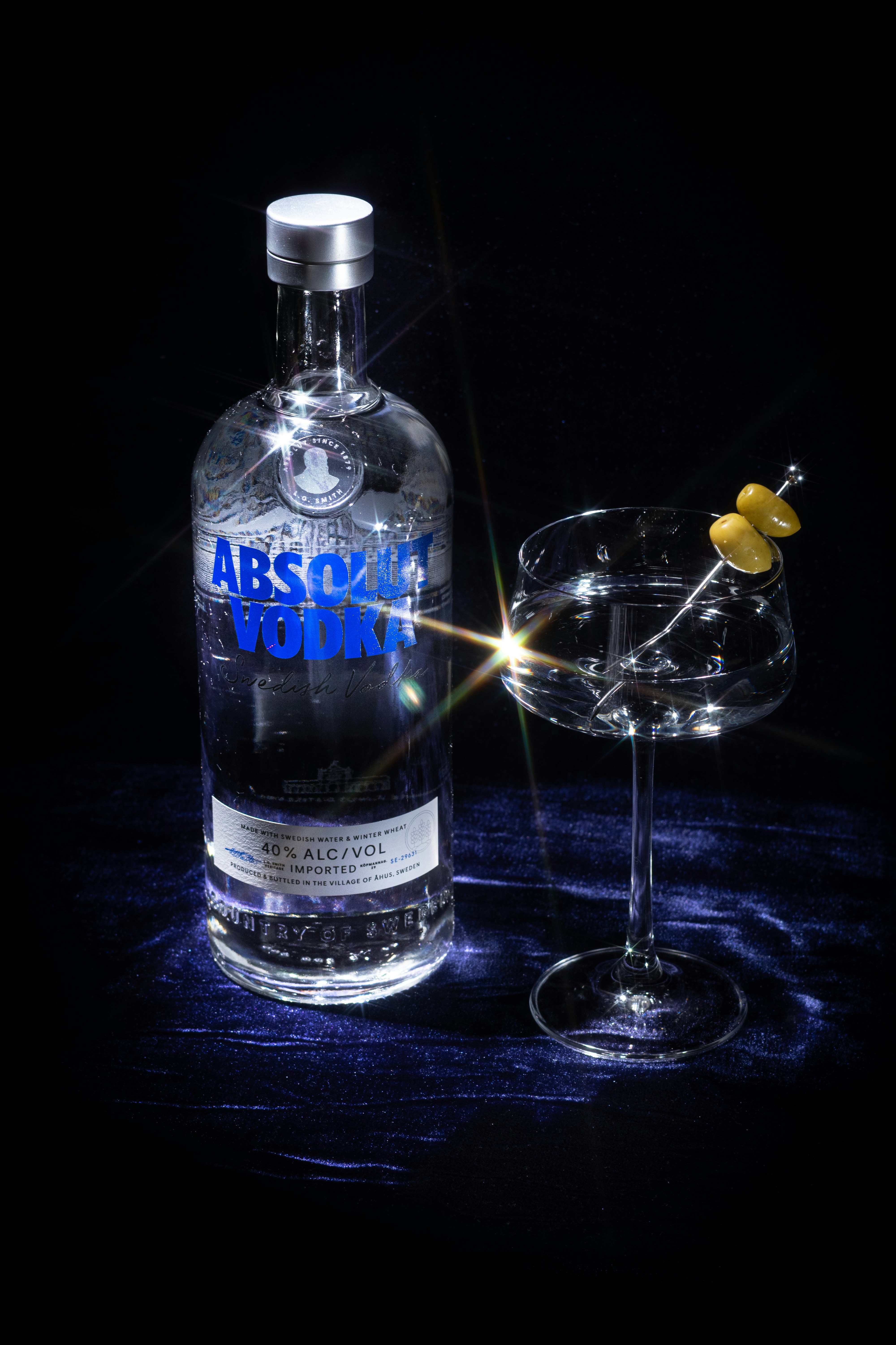 Absinthe Nightcap: A Bottle and Glass Under Starry Spotlight