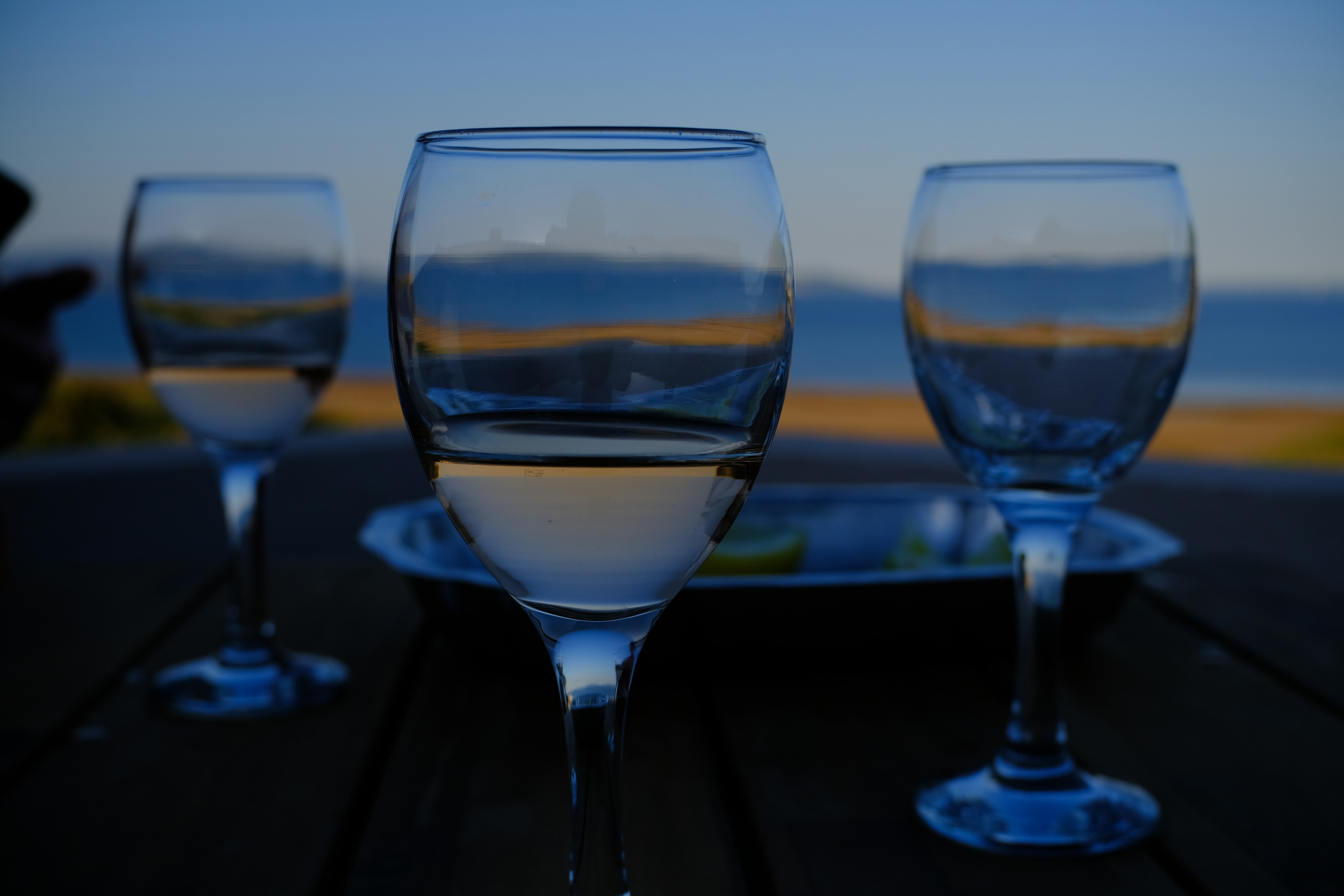 Glassware in Focus: Sunset Reflections Across a Table