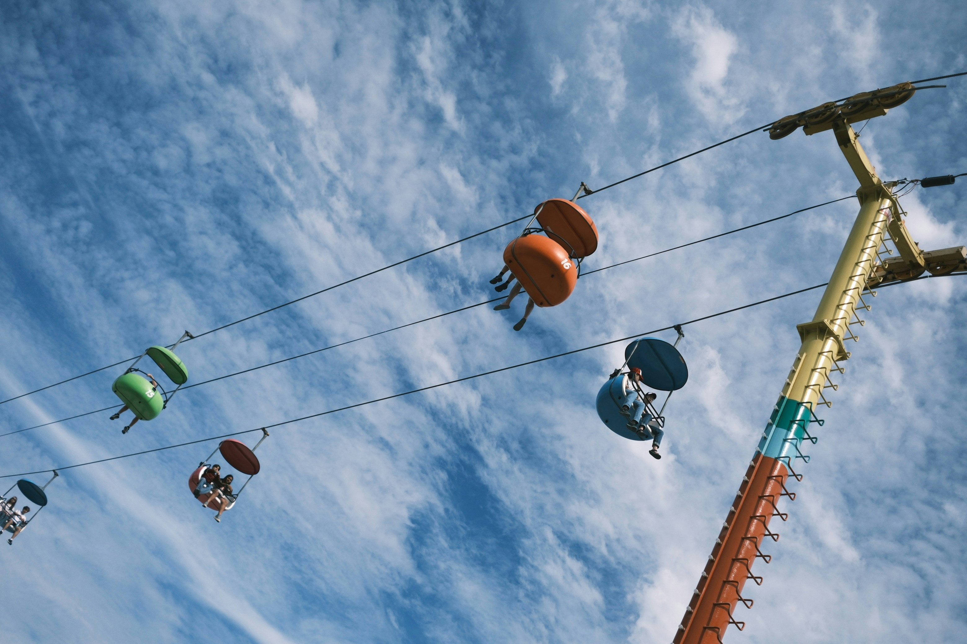 Cable Car Symphony: Colorful Rides Across a Blue Sky